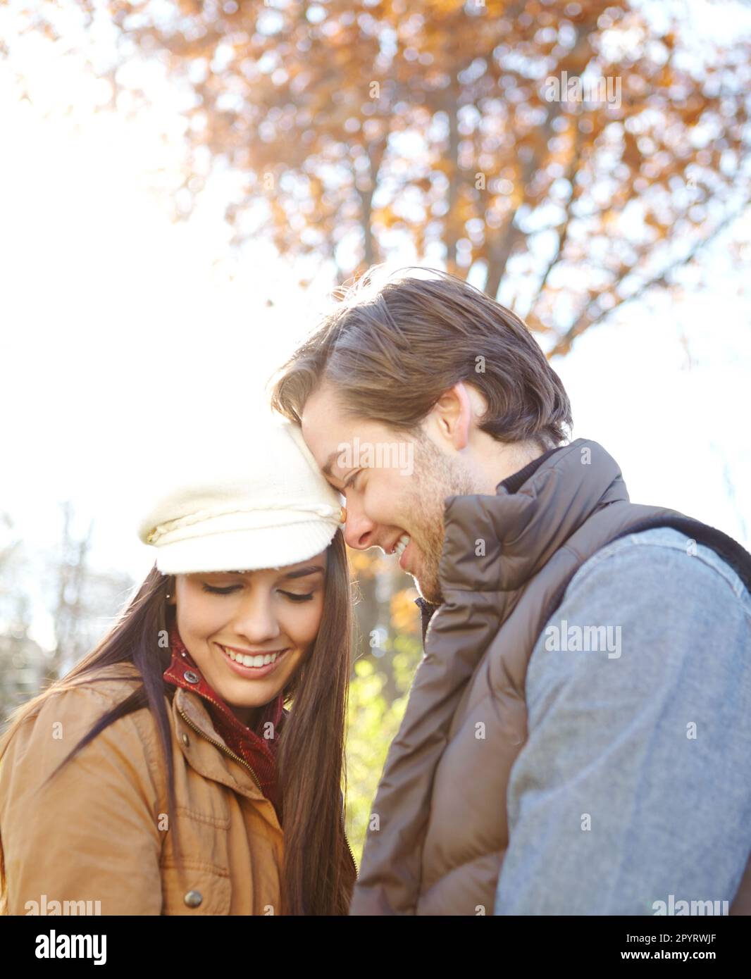 Whispering Sweet Nothings A Loving Young Couple Standing Together Outdoors In The Woods Stock