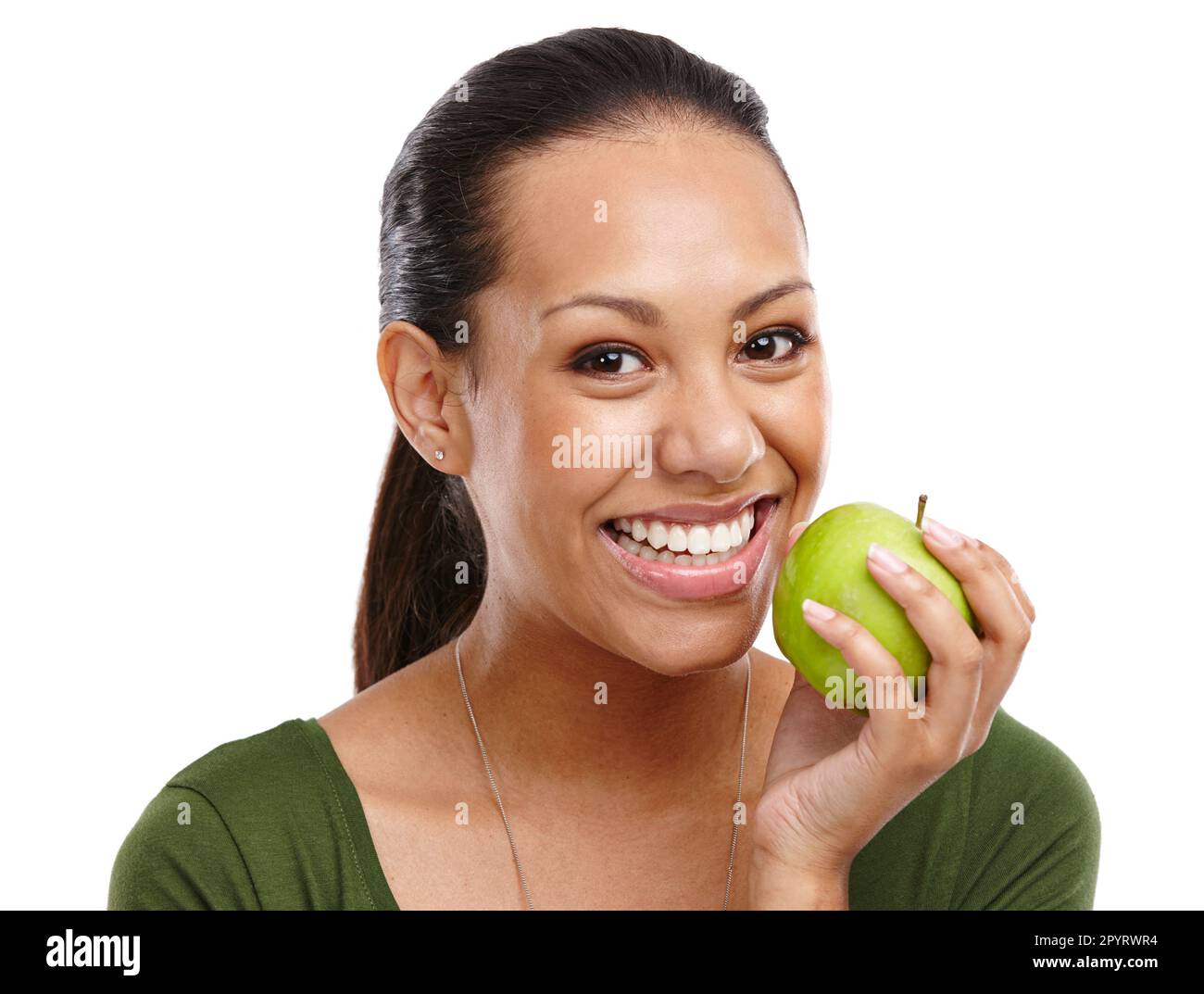 Taking a bite of natures medicine. Portrait of an attractive young ...