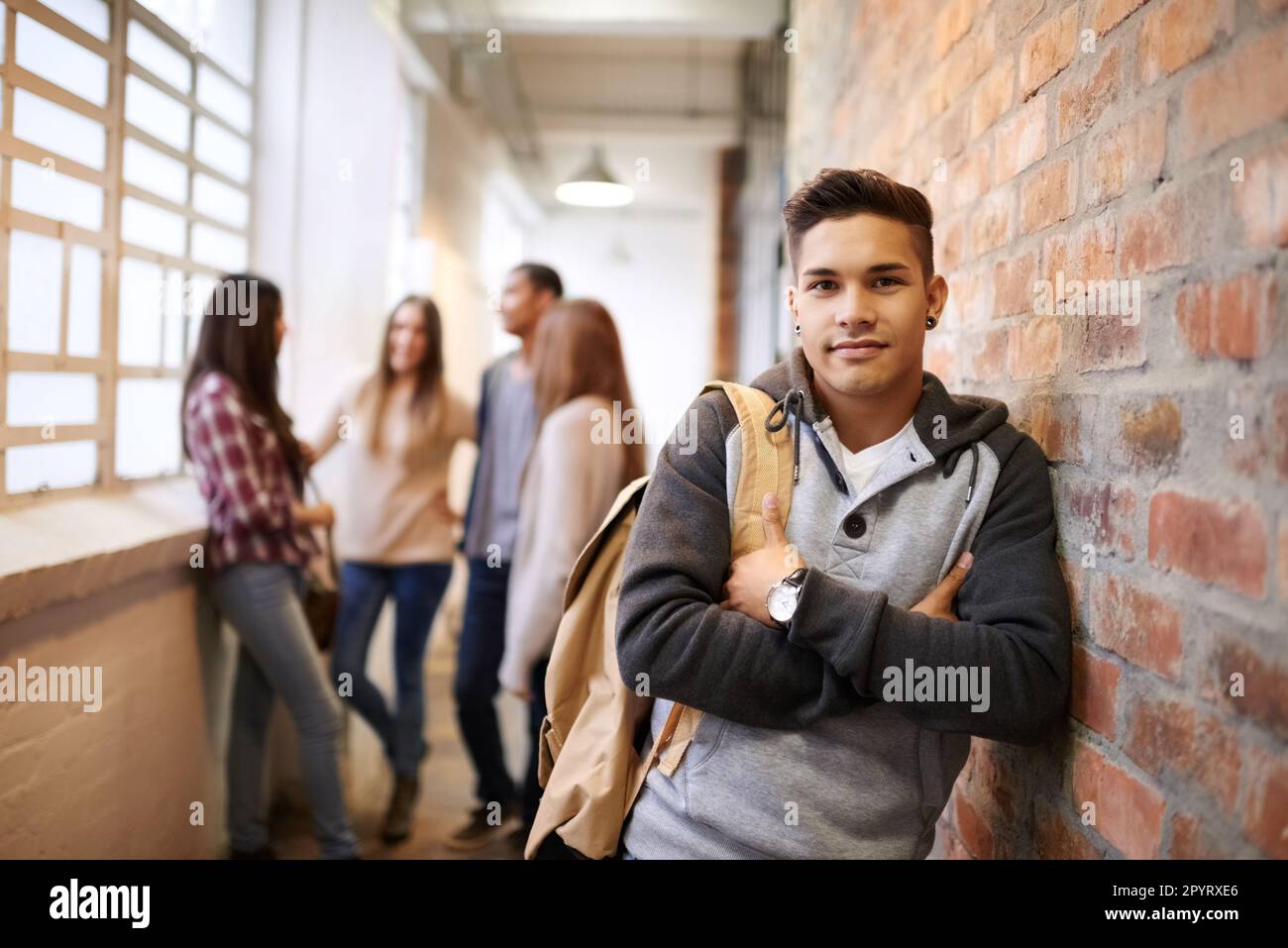 Education, arms crossed and portrait of man in college hallway for ...