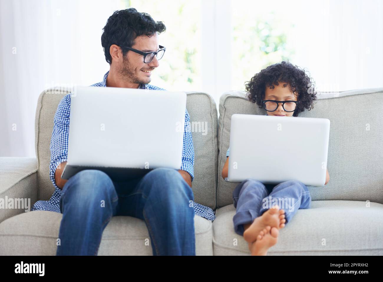 Laptop, relax and family father, child or people sitting on home sofa ...