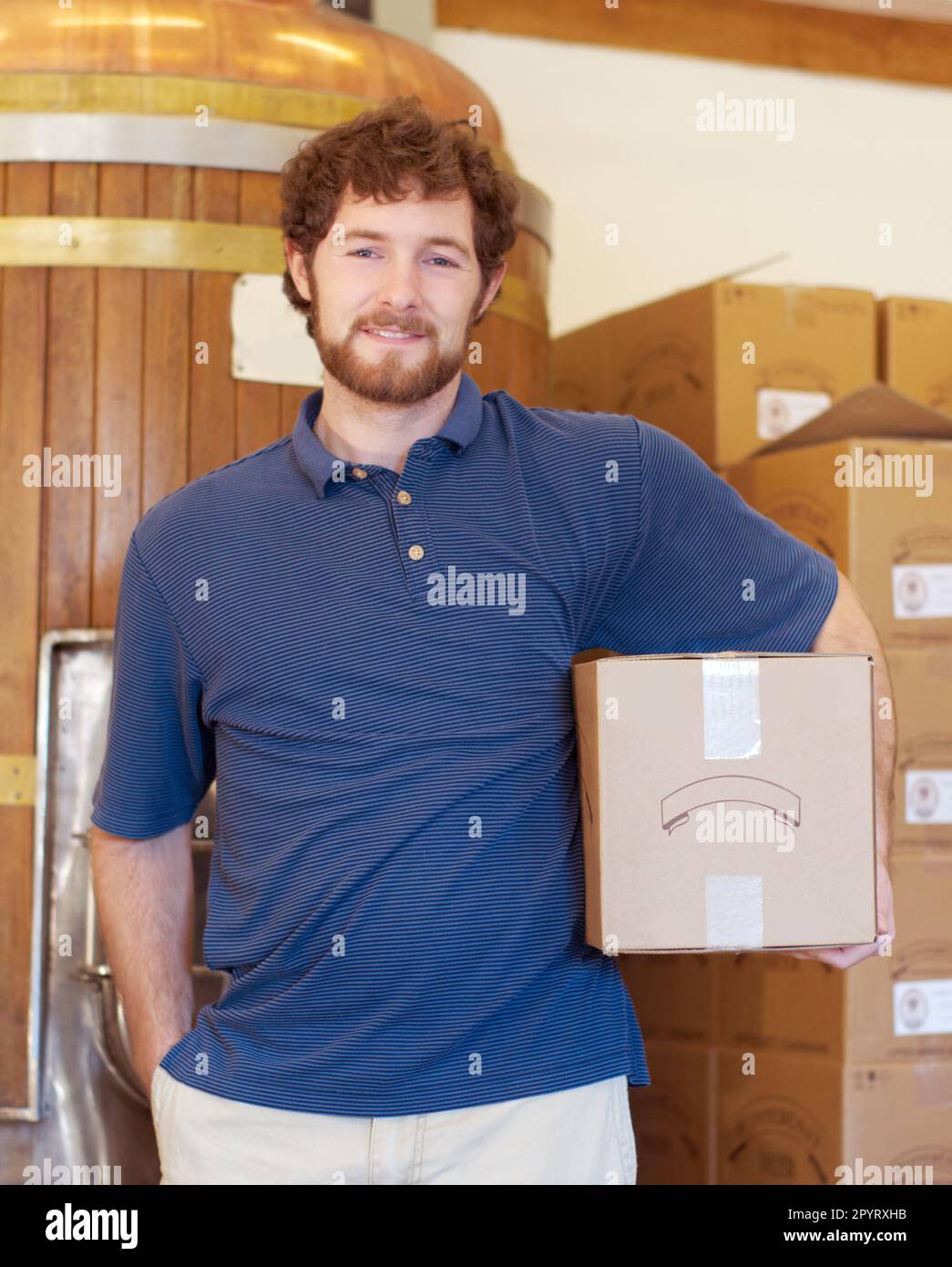 Portrait, beer and box with a man in a brewery for the production ...