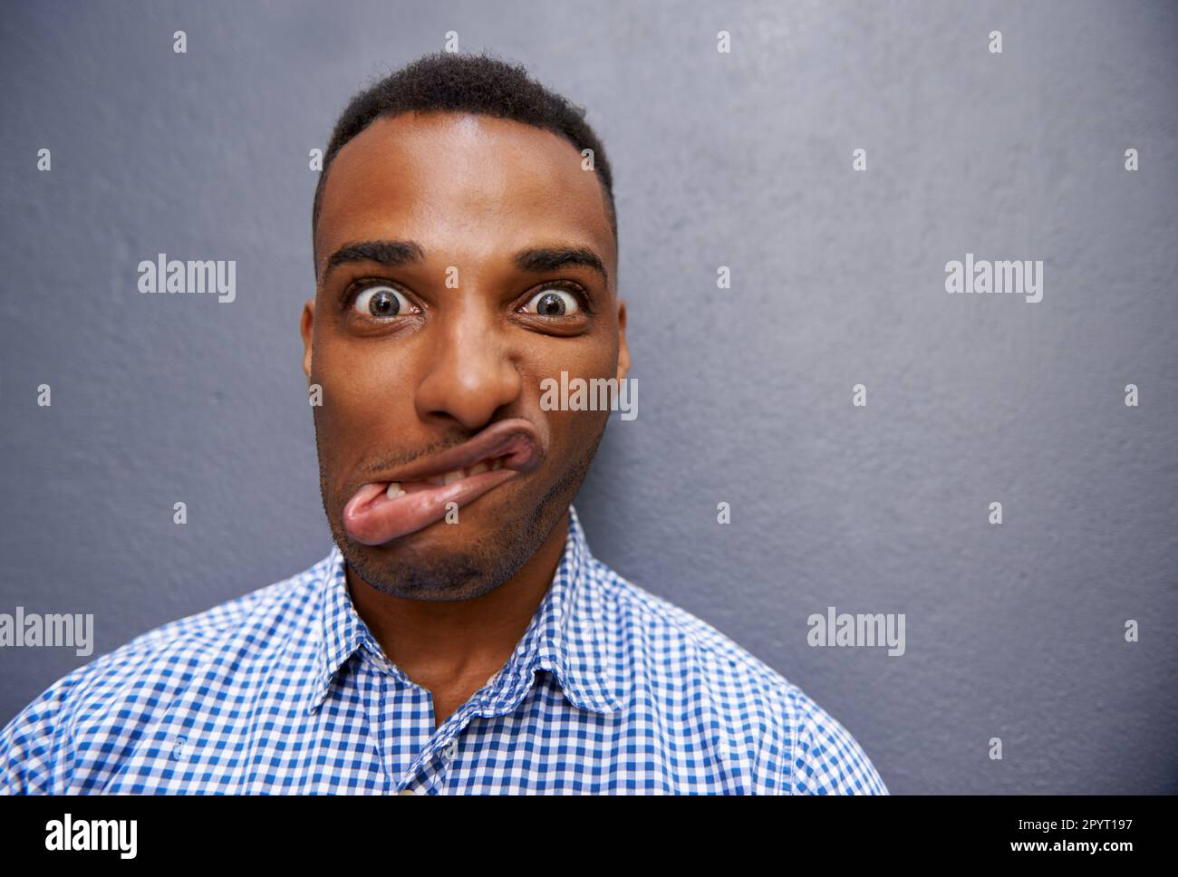 My, what a big mouth you have. Portrait of a young man with a ...