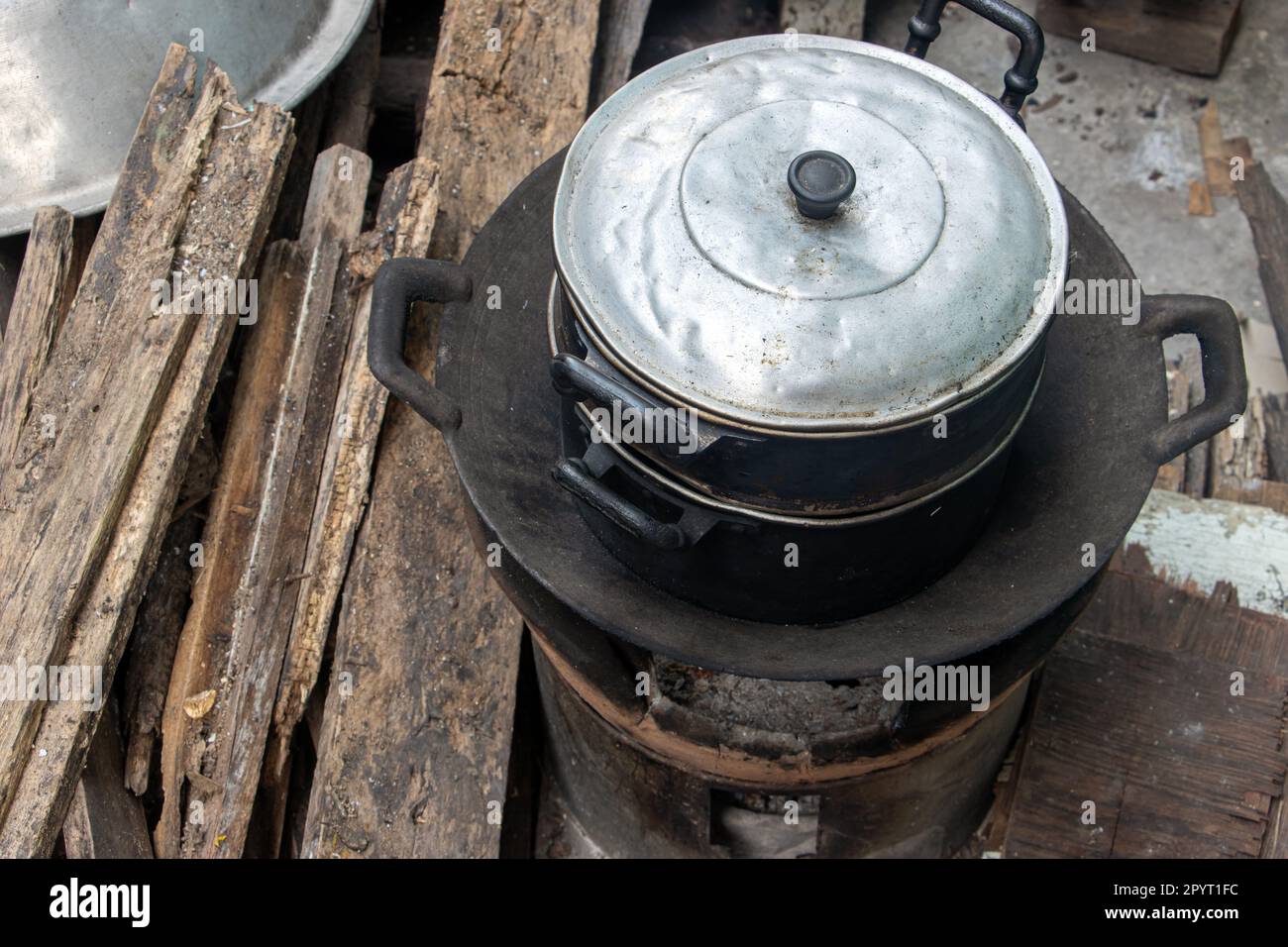 Traditional outdoor fire pit with dishware and wood in the backyard of ...