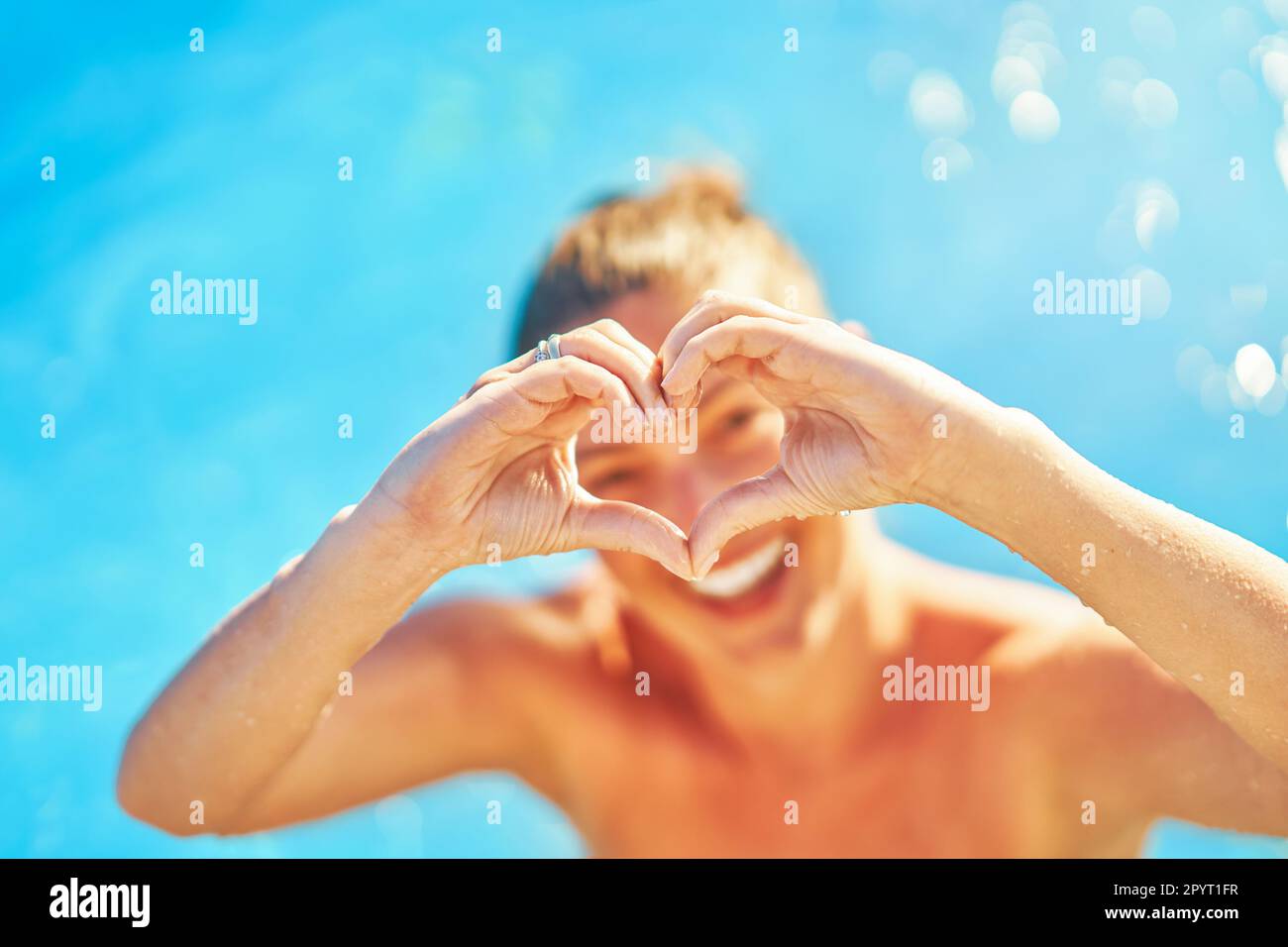 Picture of woman in swimming pool showing heart with her hands Stock ...