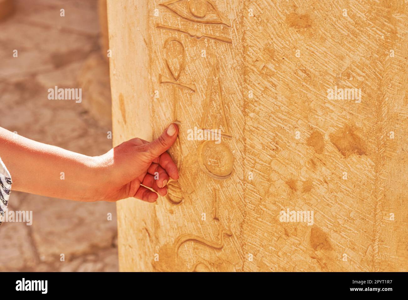 Image of hand touching Egyptian hieroglyphs in Mortuary Temple of ...