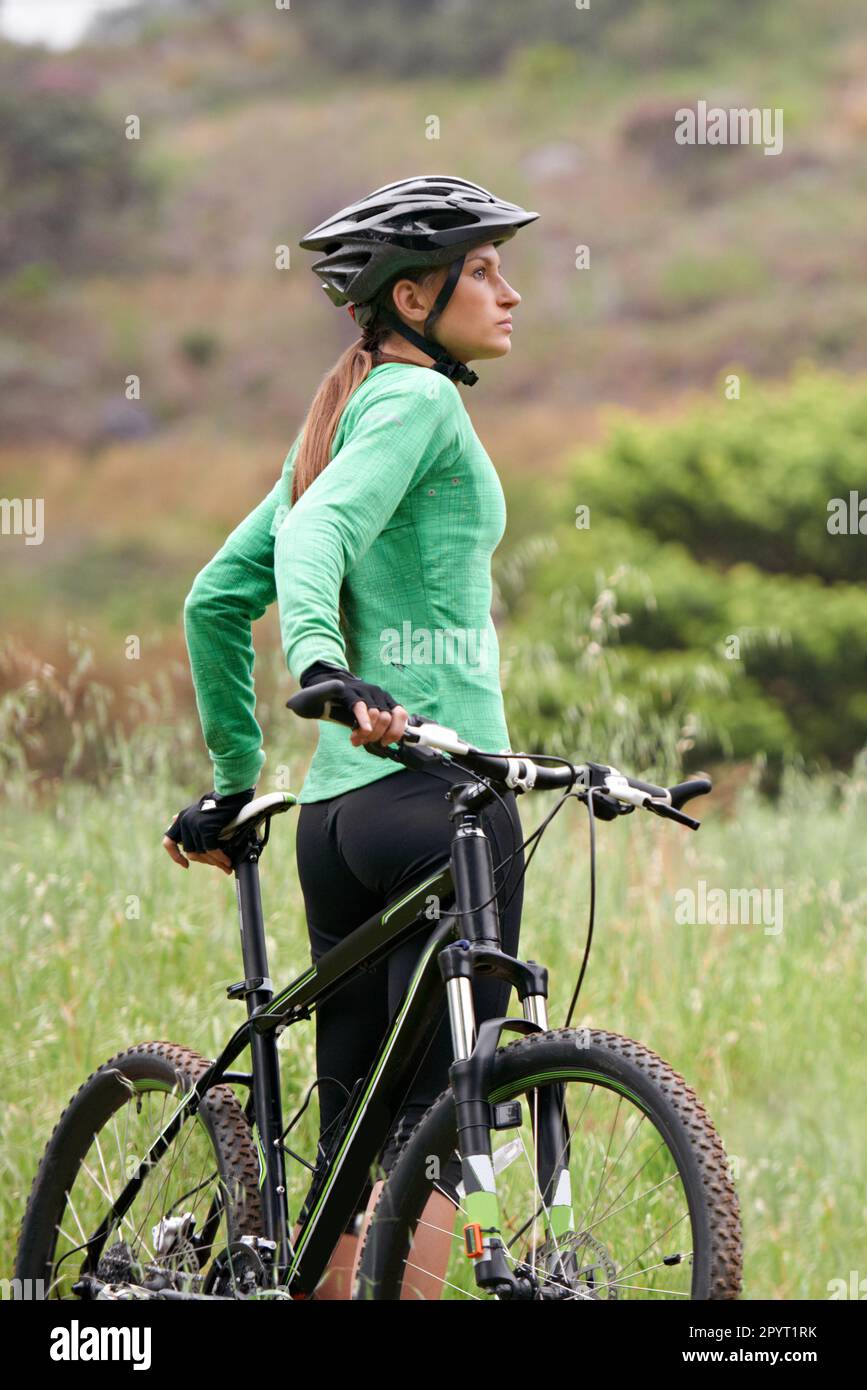 She bikes for the freedom. An attractive female cyclist standing ...