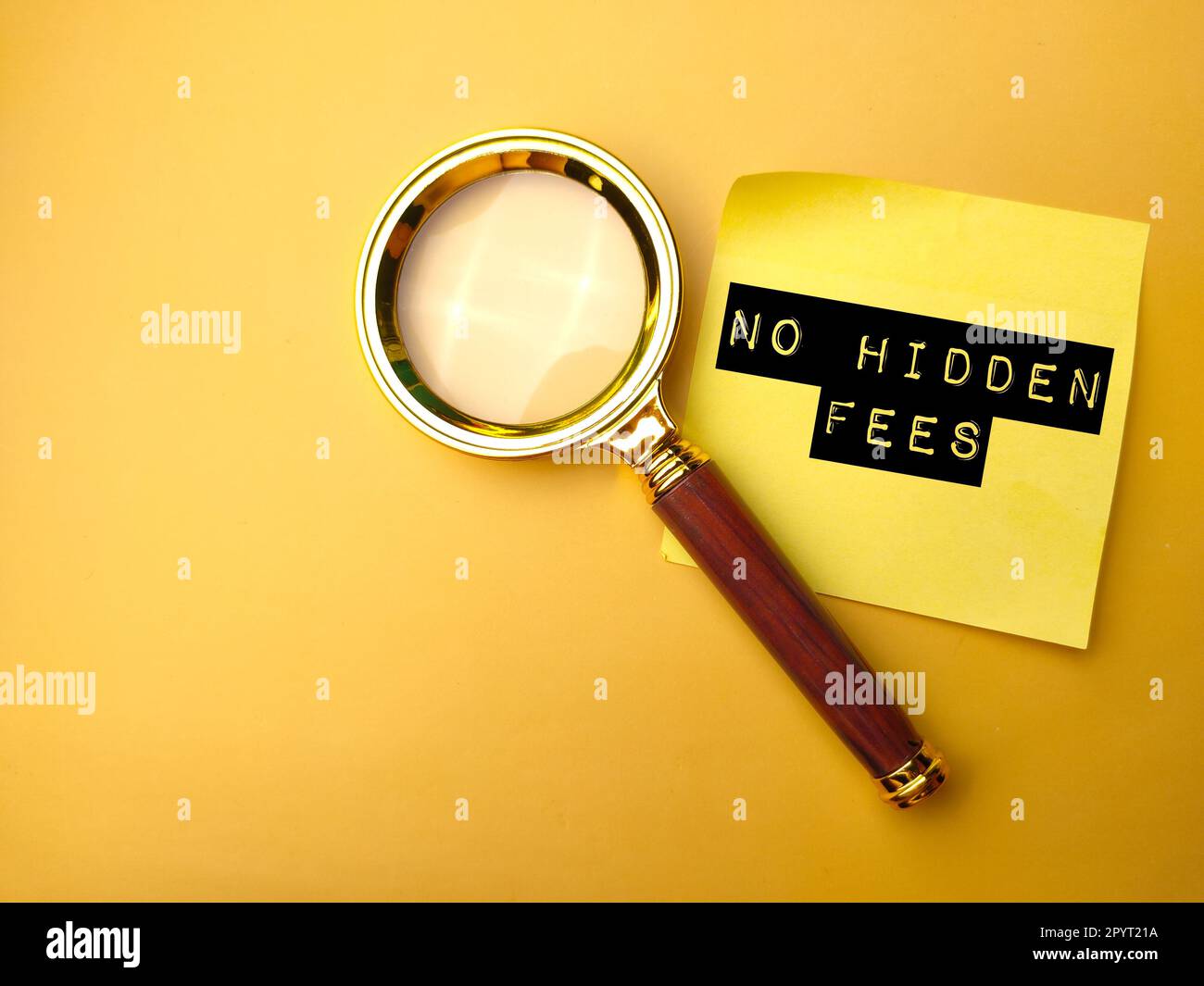 Magnifying glass and sticky note with the word NO HIDDEN FEES Stock ...