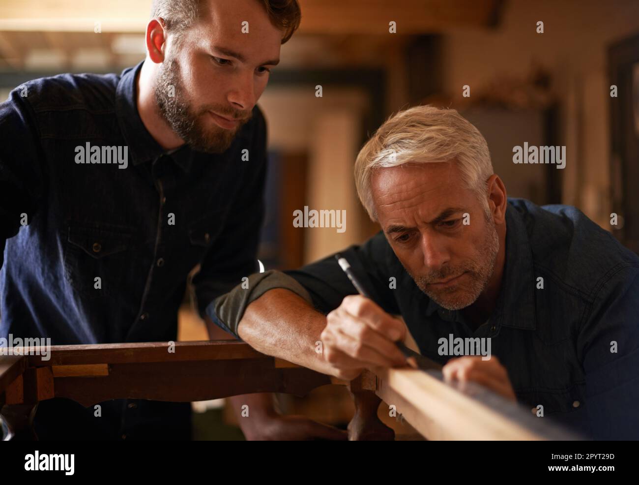 Teaching, learning and carpentry apprentice and help with pencil in ...