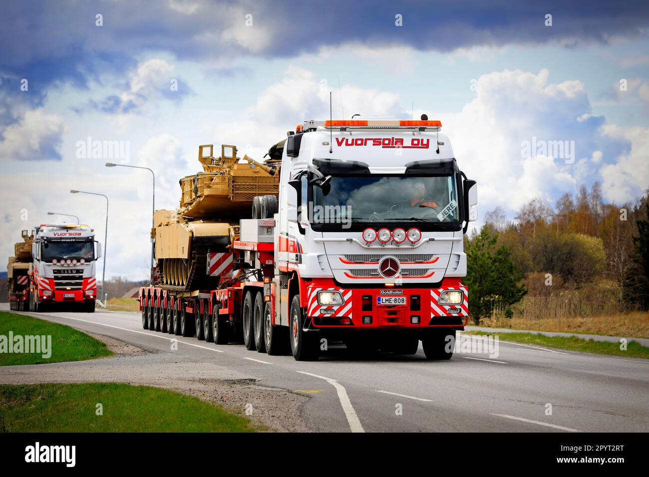 Mercedes-Benz truck hauls American M1 Abrams military tank on semi ...