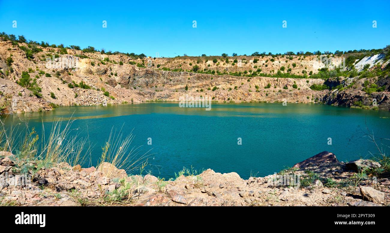Old abandoned quarry lake filled with emerald water with radon Stock ...