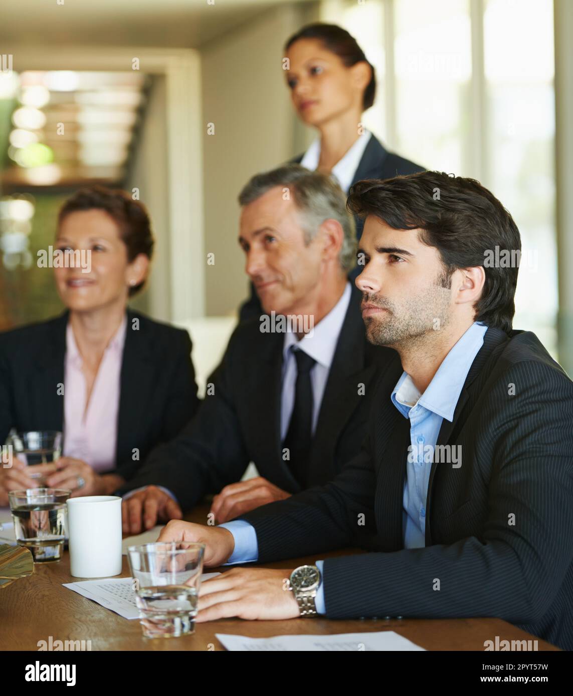 Focused on the meetings agenda. A group of businesspeople having a ...