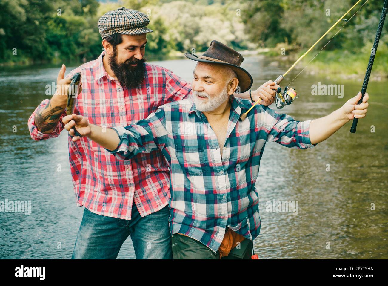 Two men friends fishing. Flyfishing angler makes cast, standing in ...