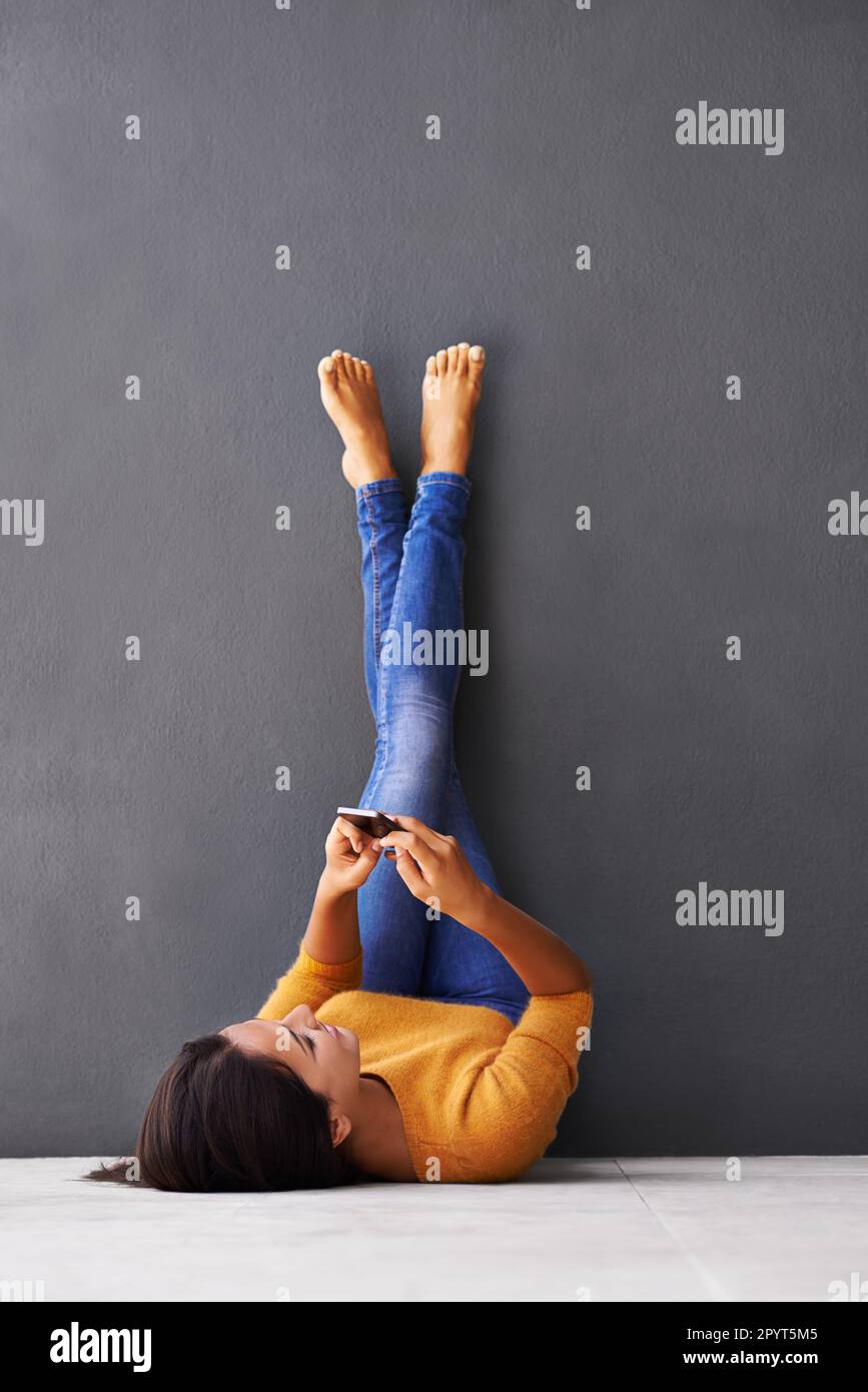 The upside-down approach to texting. A young woman using a mobile phone ...
