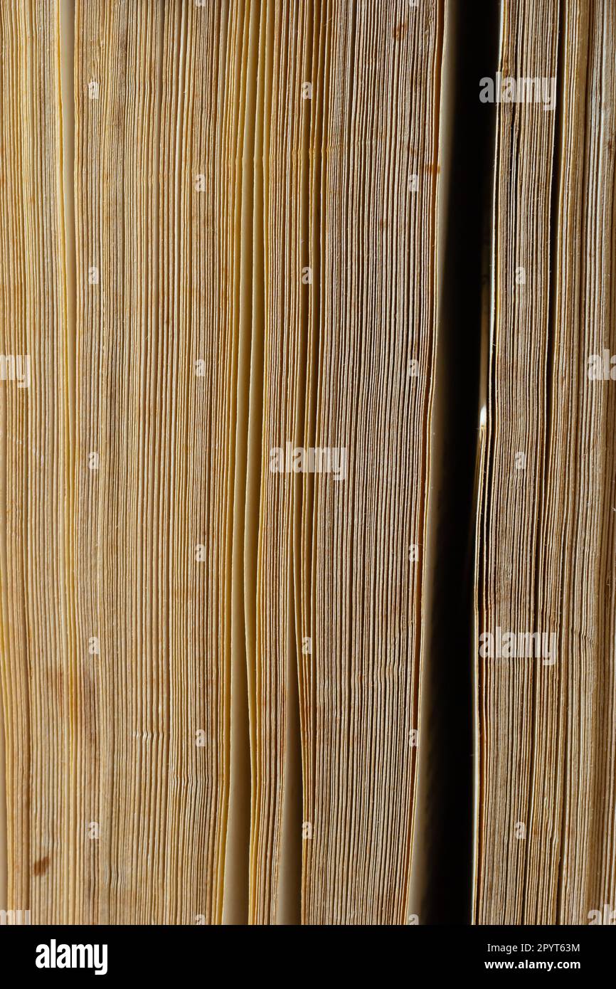Book background. Stack of books in the library. Old yellow pages of ...
