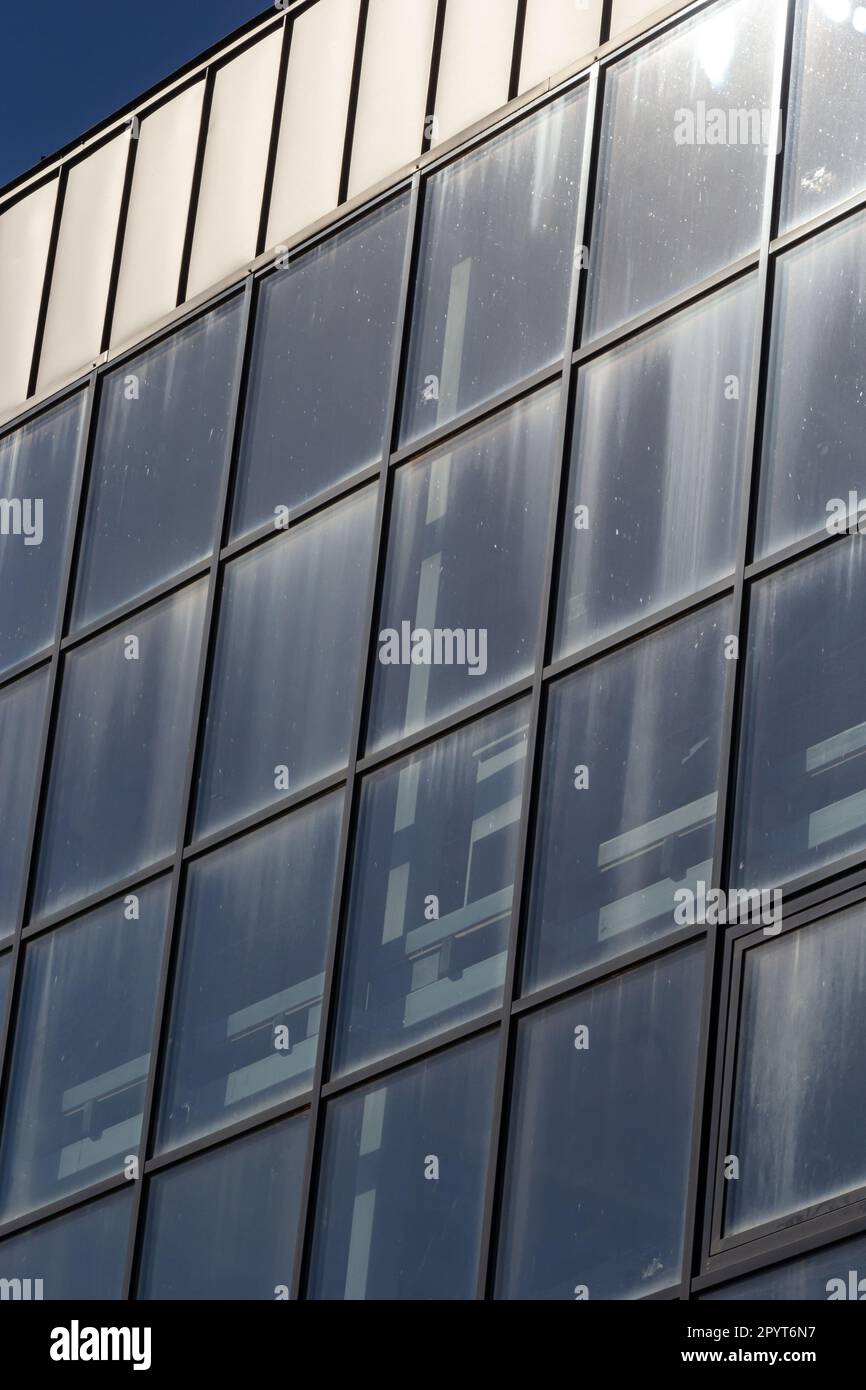 Bottom view of a modern skyscraper building with glass window against ...