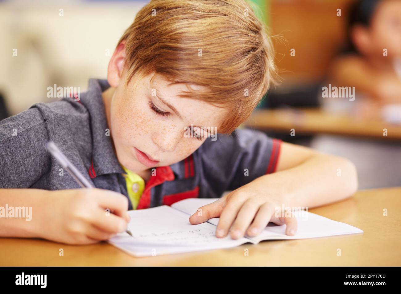 Education, student and boy writing, focus and learning with creativity ...