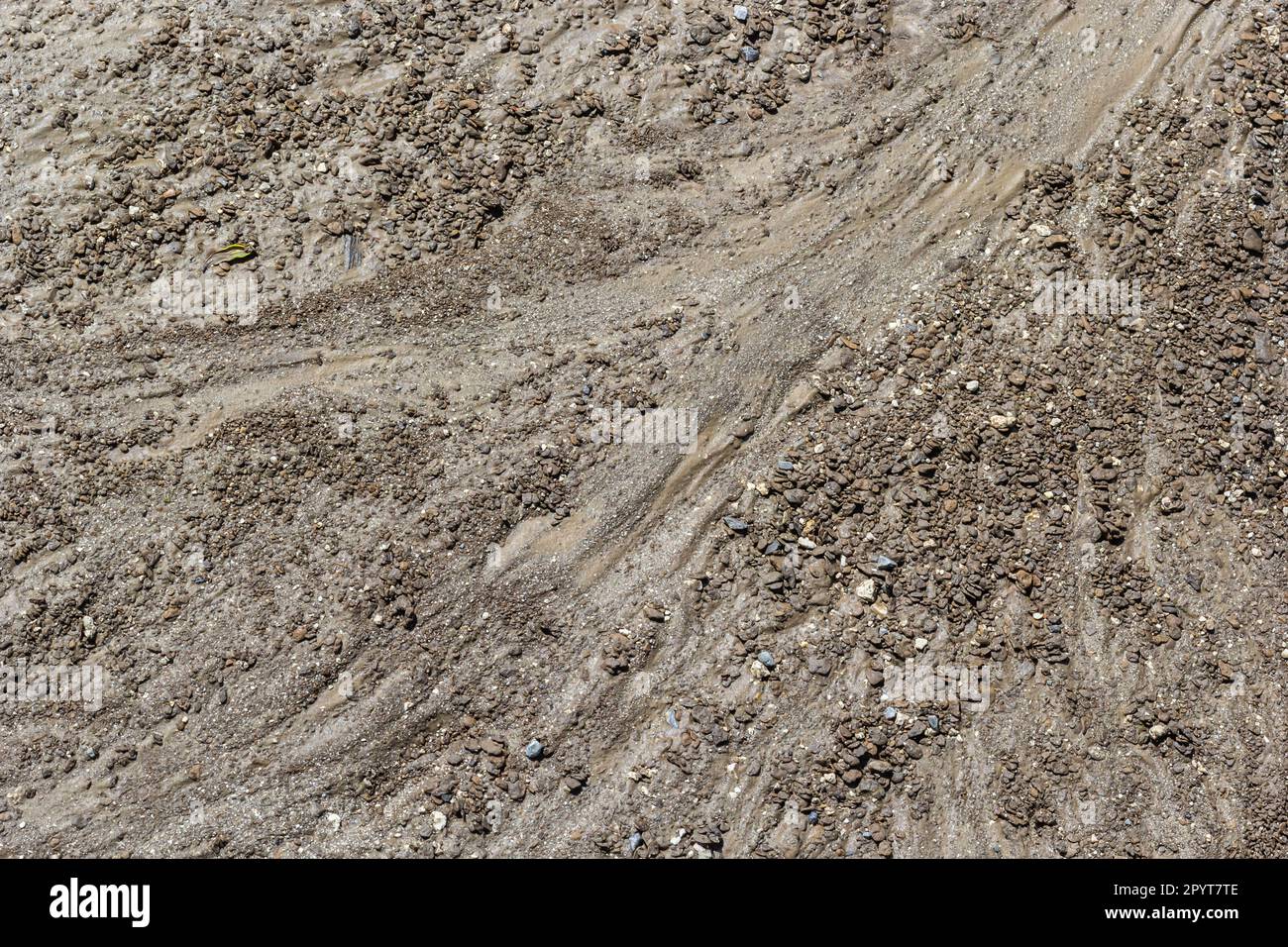 Dirty washed dirt road with traces of water flow in spring. Off-road ...