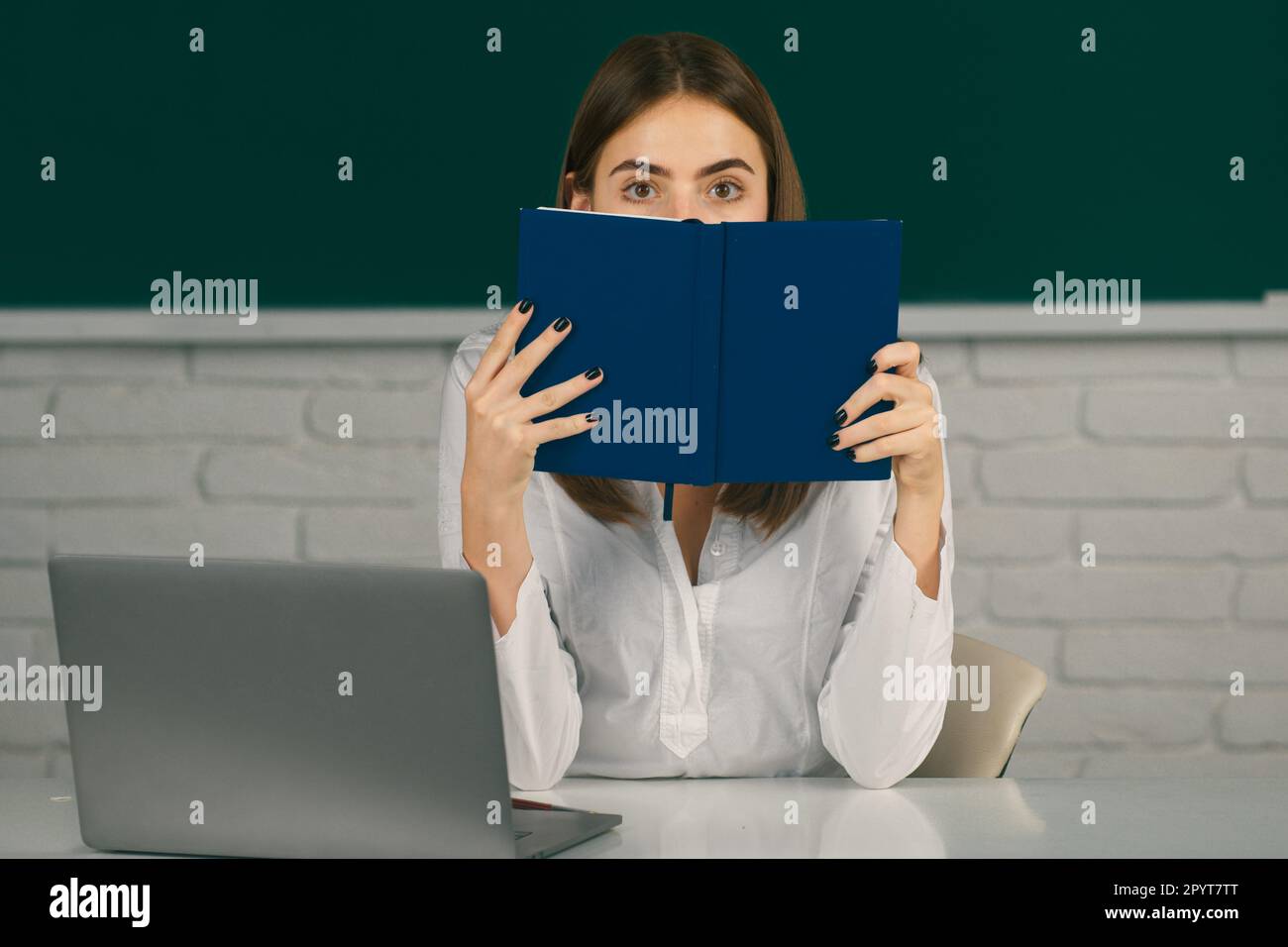 Student preparing exam and learning lessons in school classroom. Female ...