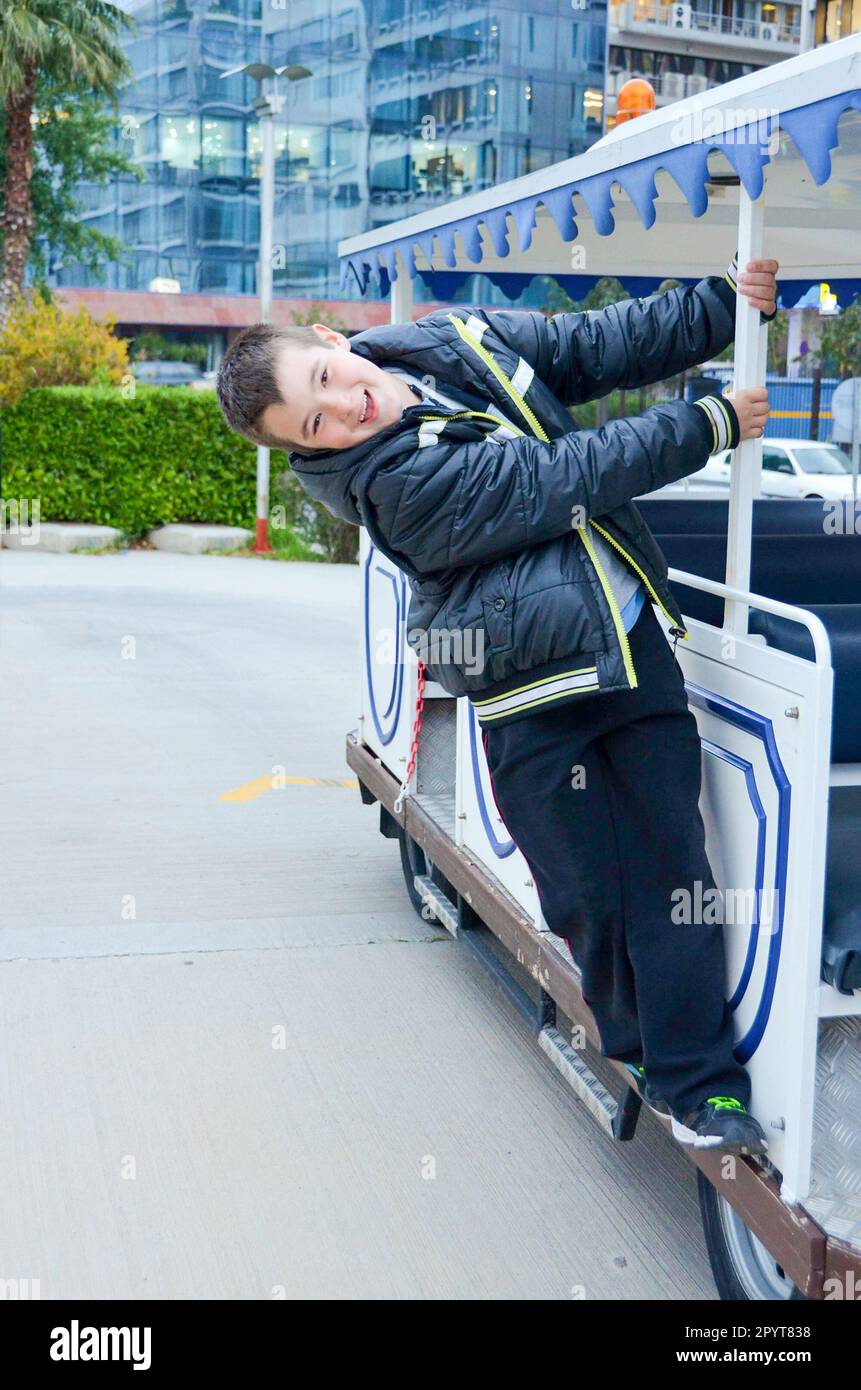 Happy boy playing and hanging on the side of sightseeing train Stock ...