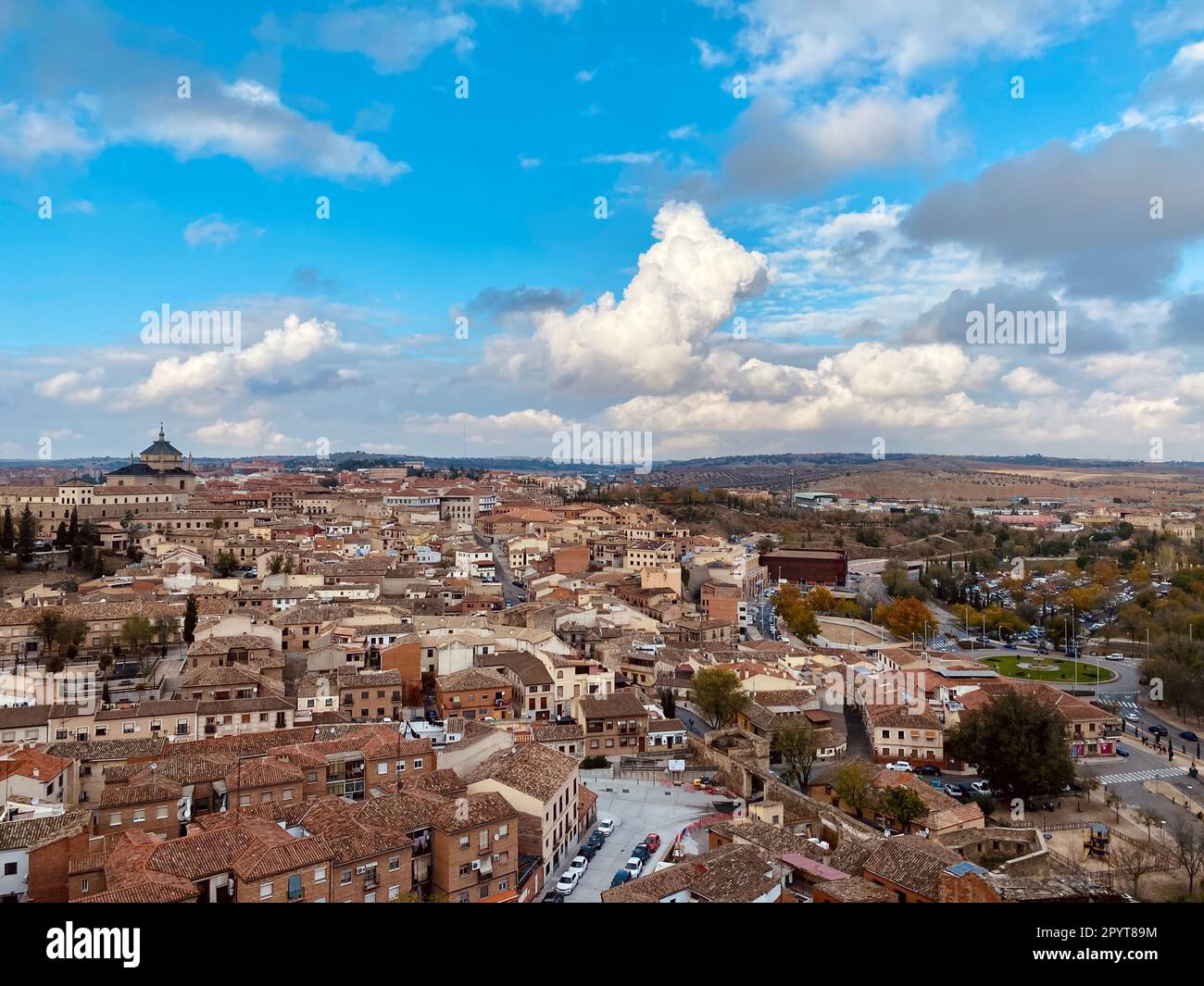 An idyllic scene of a Spanish town with a castle in the background and ...