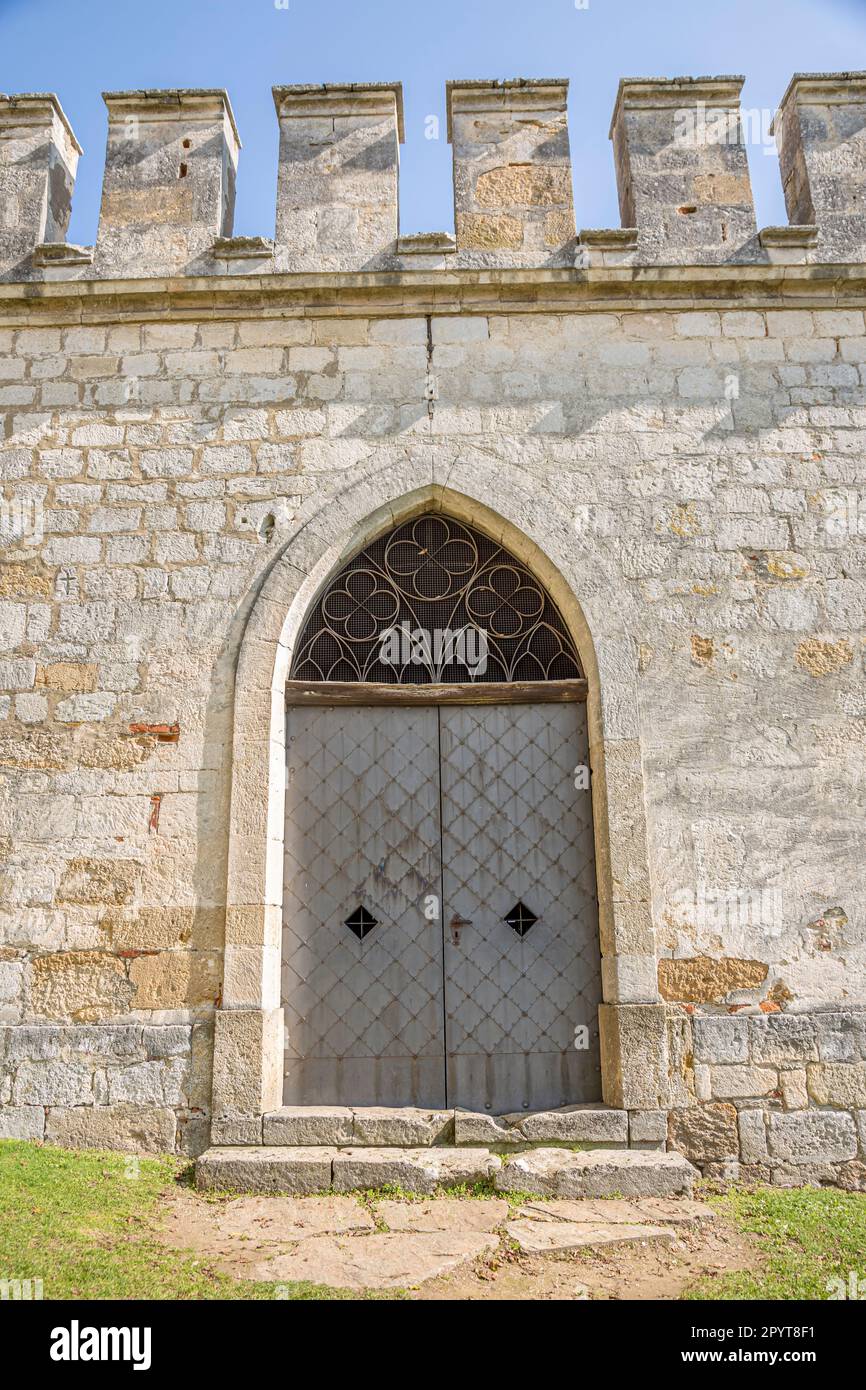 Old castle stone wall with closed big metal doors. Vintage gates. Retro ...