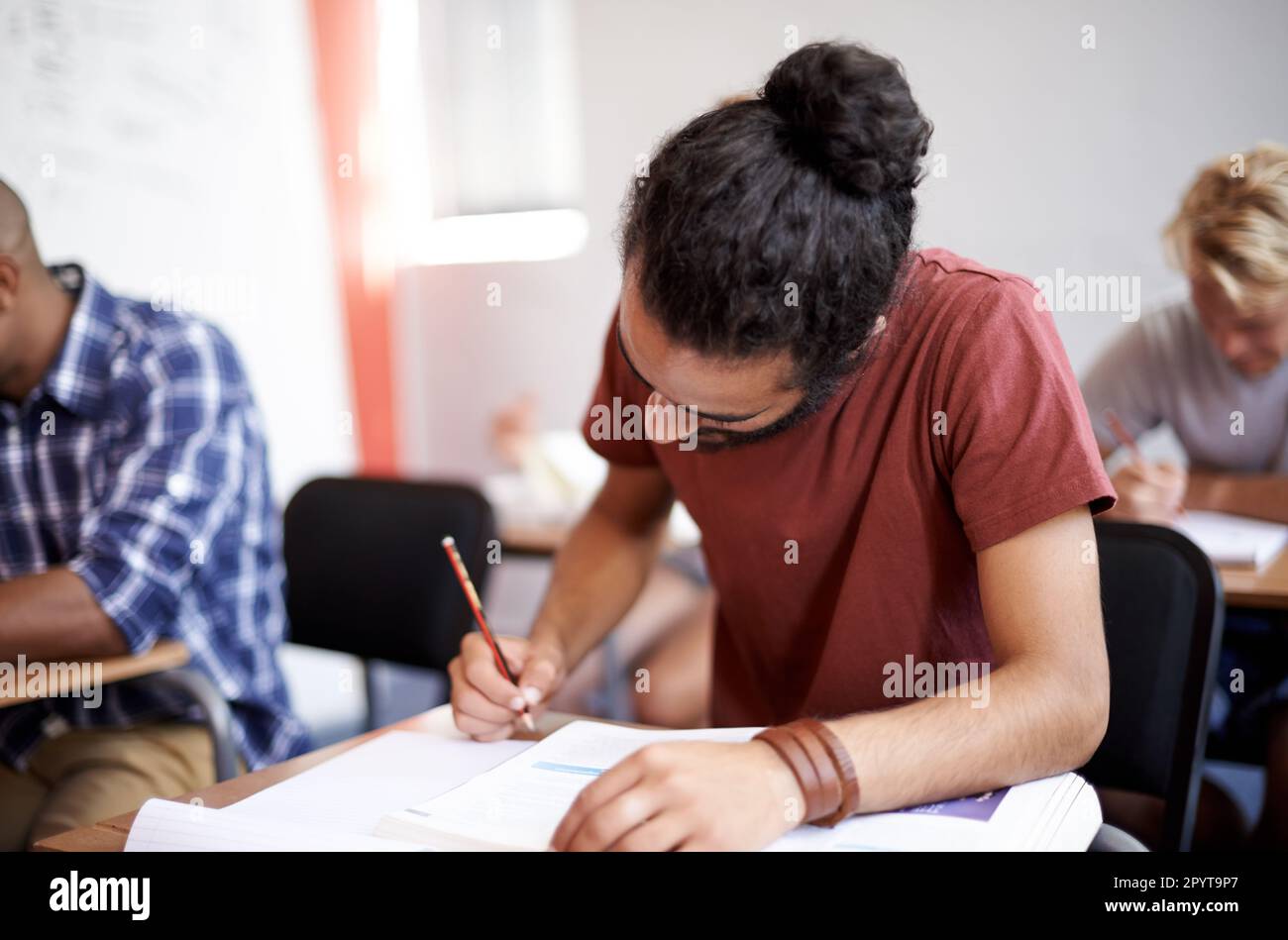 Working hard for good grades. young university students during class ...
