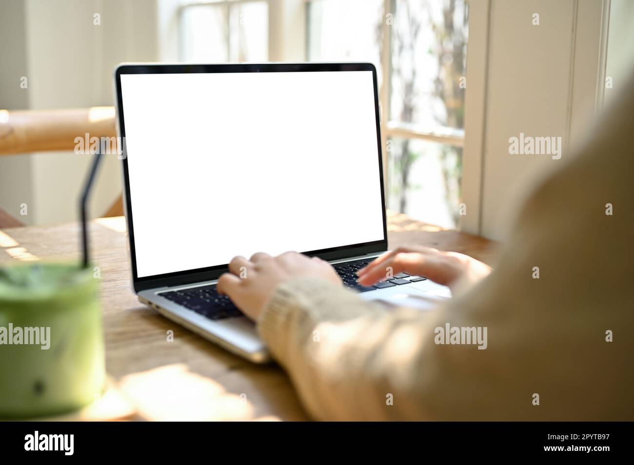 Close-up image of a female freelancer using her laptop computer, remote ...