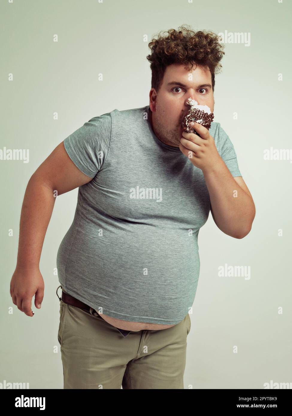 Obese man eating cake hi-res stock photography and images - Alamy
