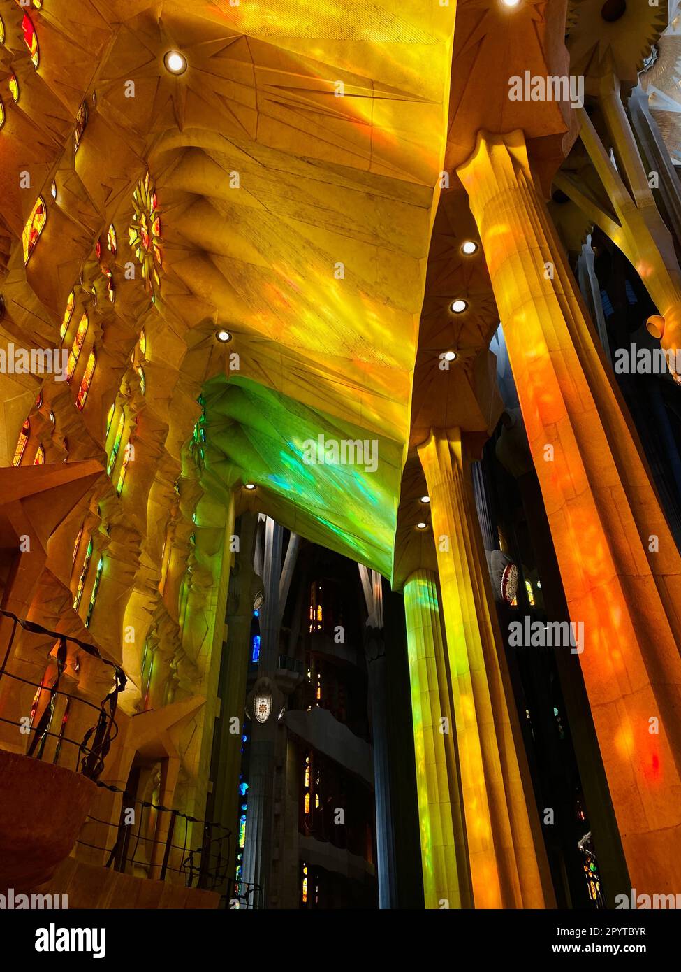 A vibrant ceiling adorned with bright lights adjacent to a stained ...