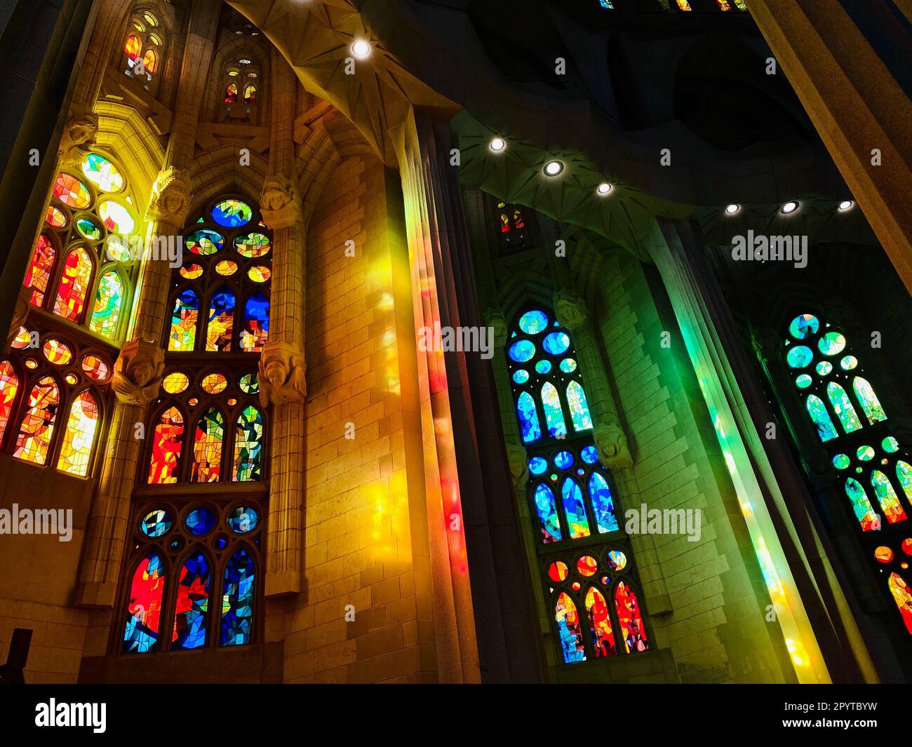 A spectacular sight of a vast room filled with colorful stained glass windows, adorned with ...
