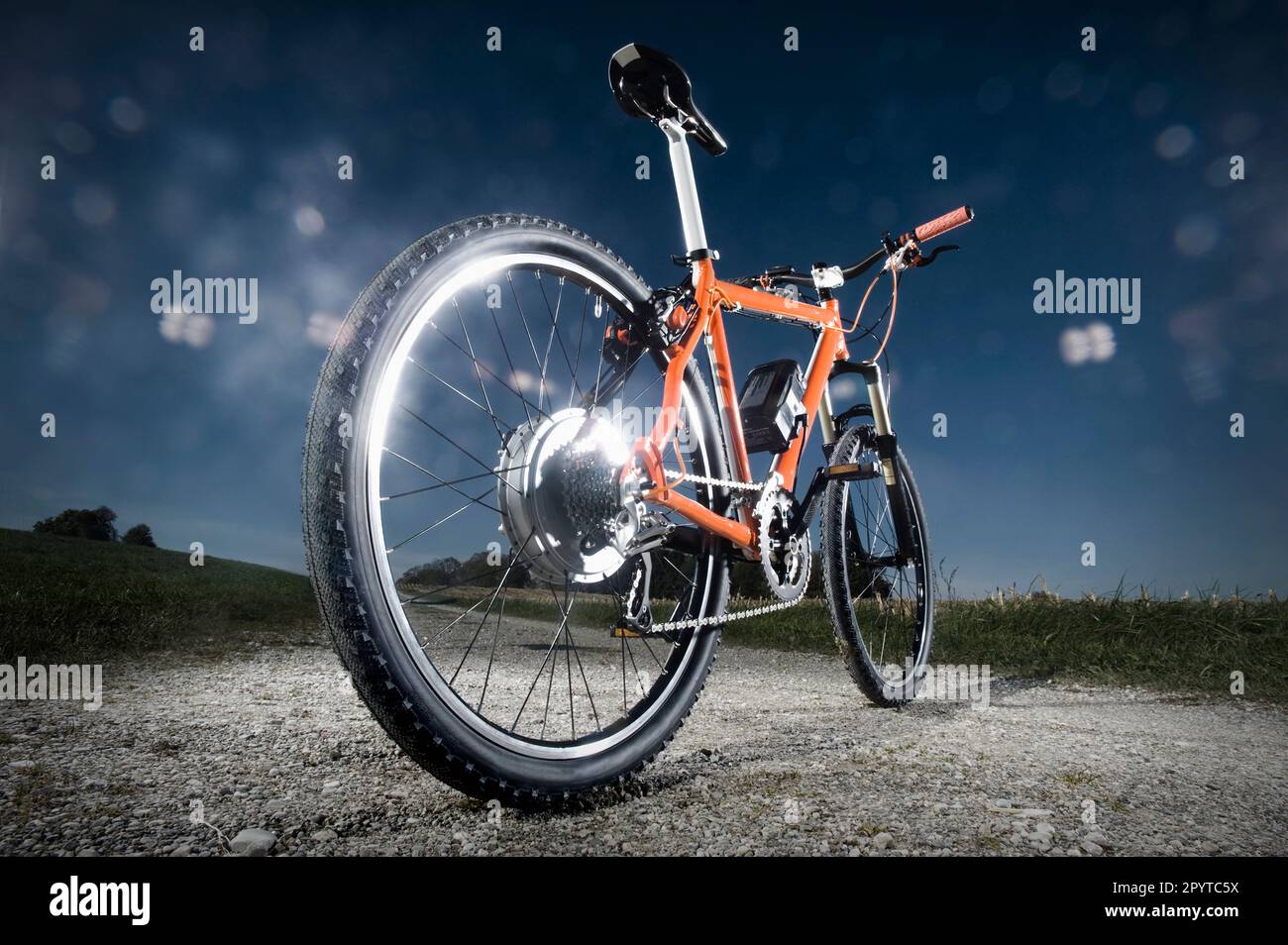 Electric bicycle standing on field Stock Photo - Alamy