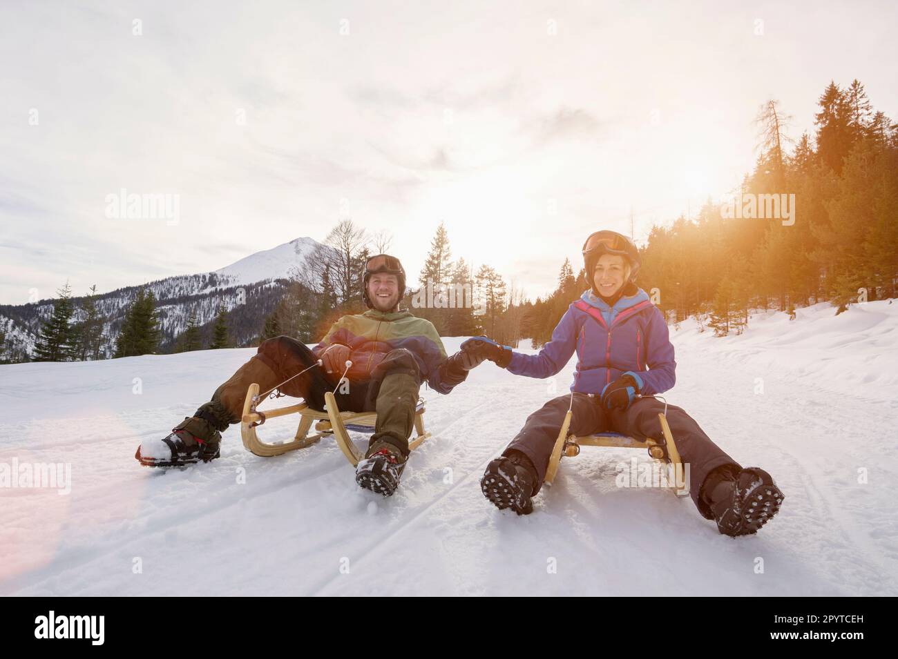 Couple sledding on winter landscape Stock Photo - Alamy