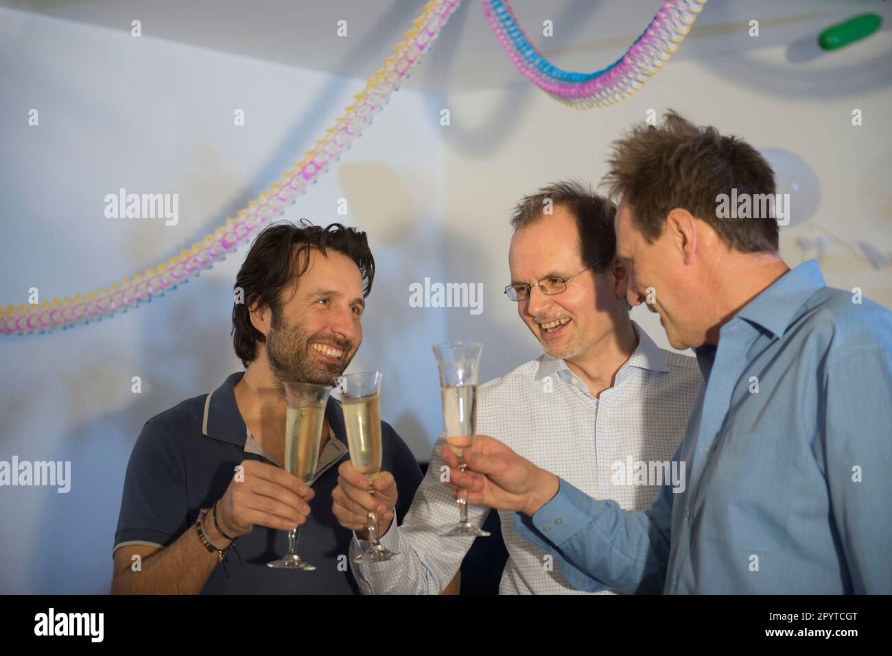 Men making celebratory toast with sparkling wine Stock Photo - Alamy