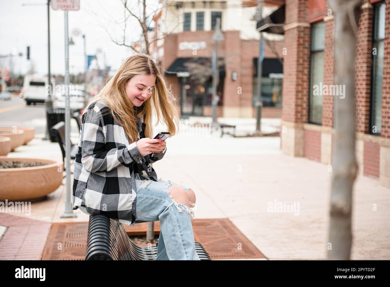 Happy blond teen on her cell phone Stock Photo - Alamy