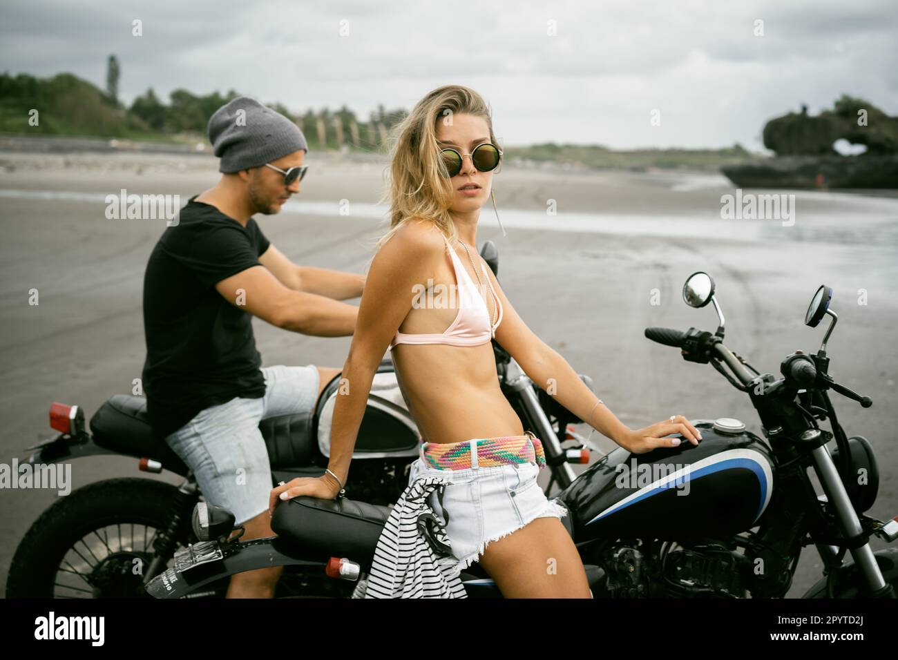 Stylish couple on motorcycles on the ocean beach. Bali Stock Photo - Alamy