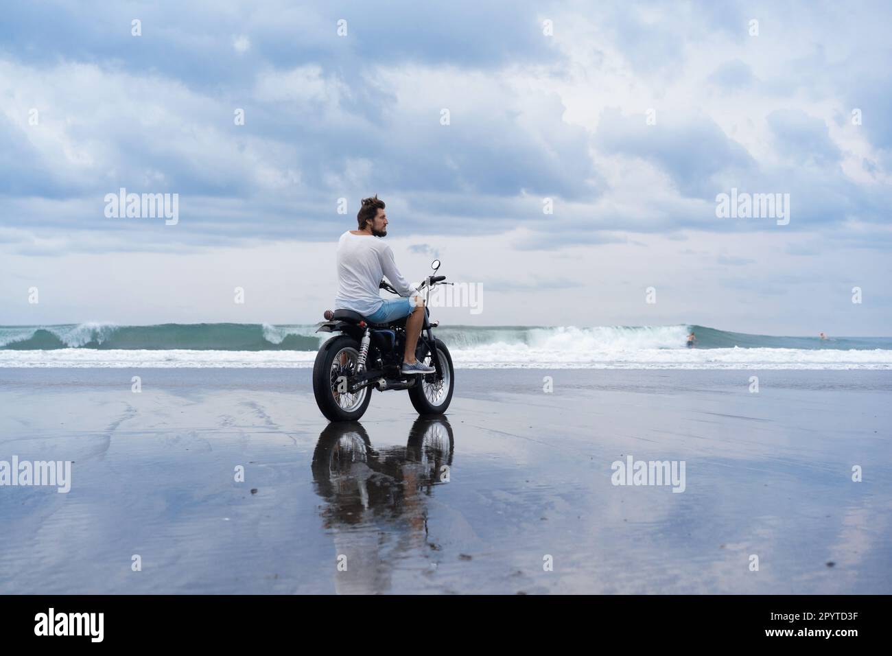 Stylish man travels on a motorcycle in the ocean beach Stock Photo - Alamy