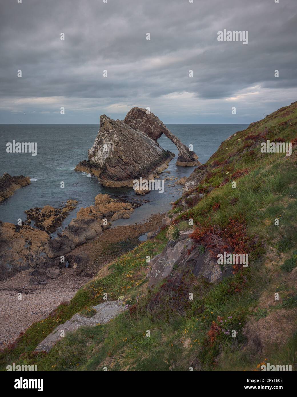 Wind and storm in the natural arch of the bow fiddle rock. Scotland ...