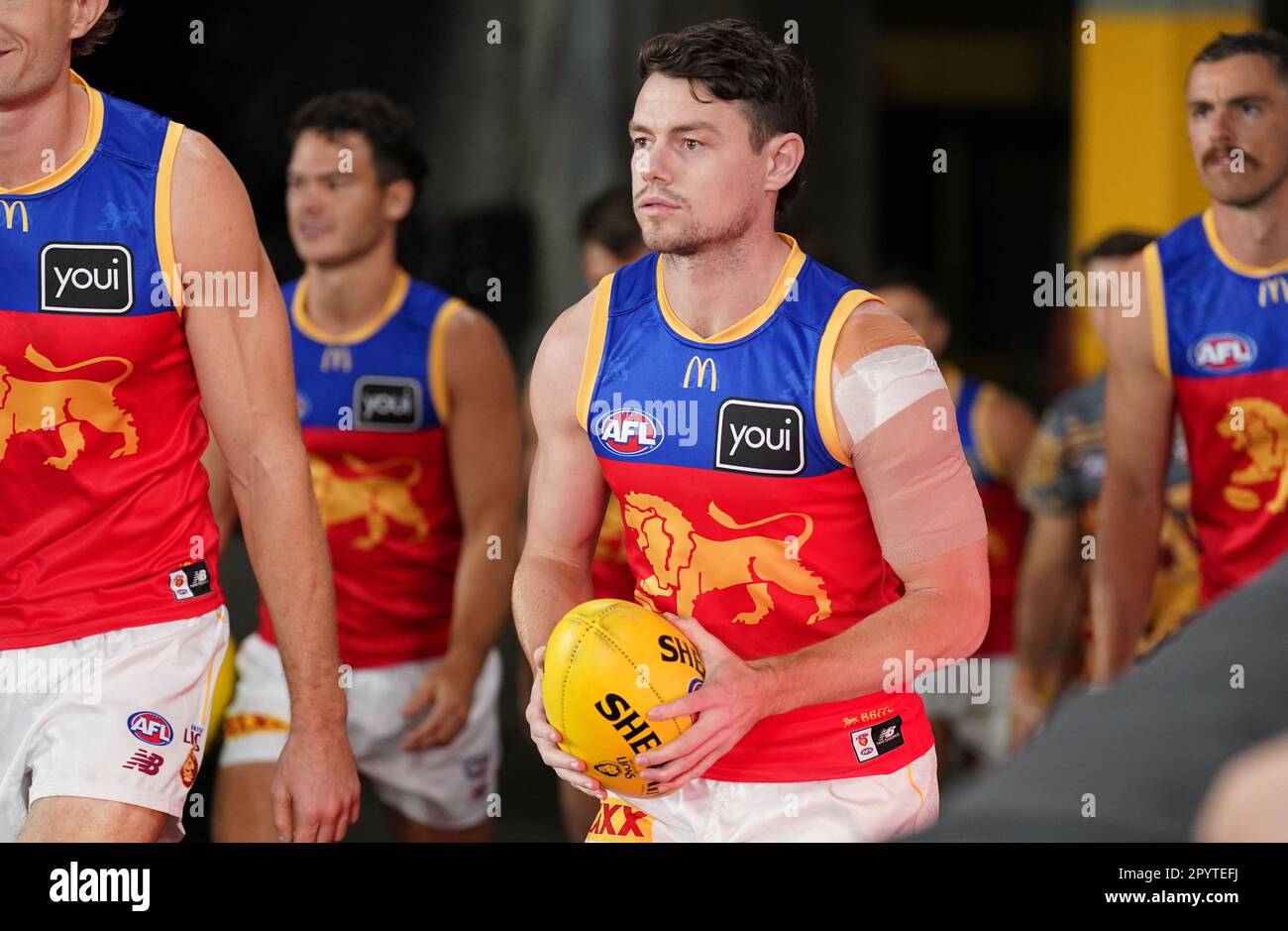 Lachie Neale of the Lions leads his side onto the field during the AFL ...