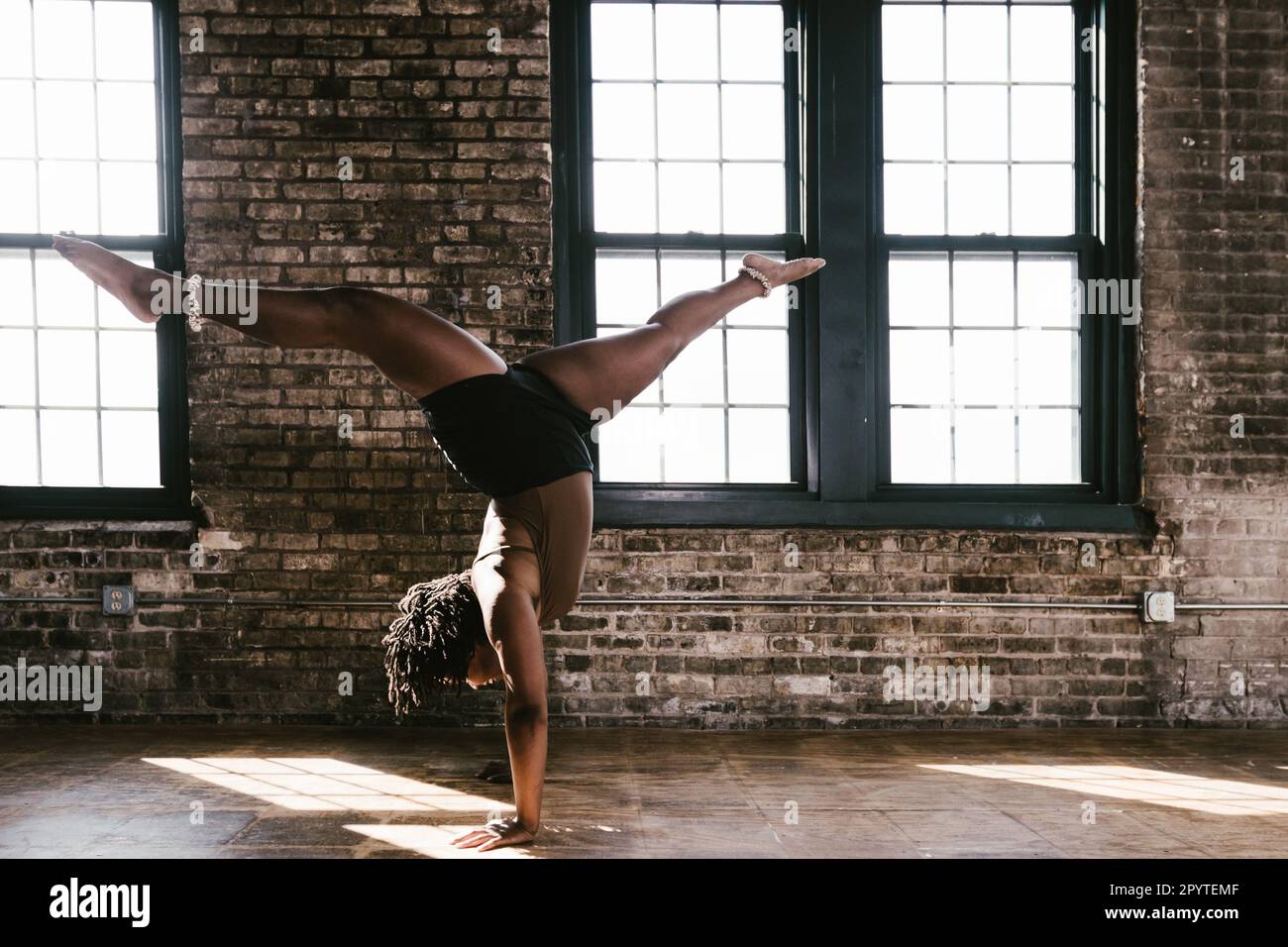 Black woman dancer in handstand split pose leg extension Stock Photo ...