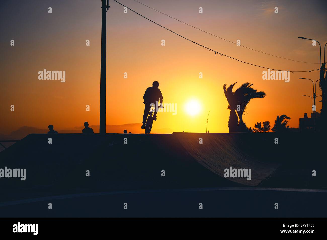 Urban athlete biker performing acrobatic jump at public park Stock ...