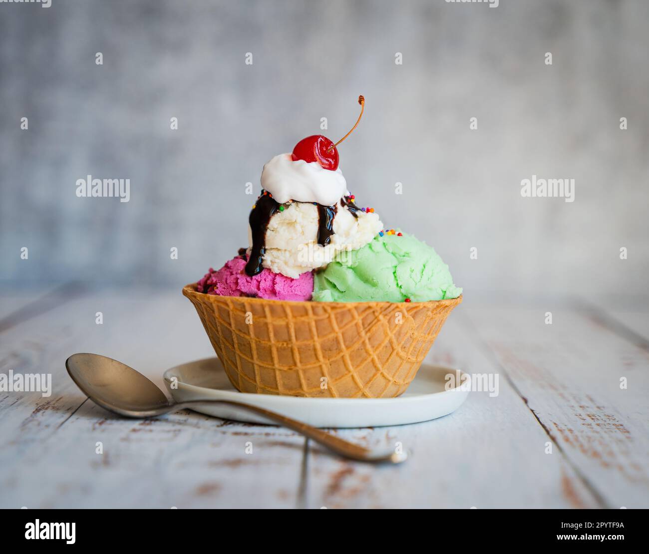 Ice cream sundae in a waffle bowl on weathered wood table Stock Photo ...