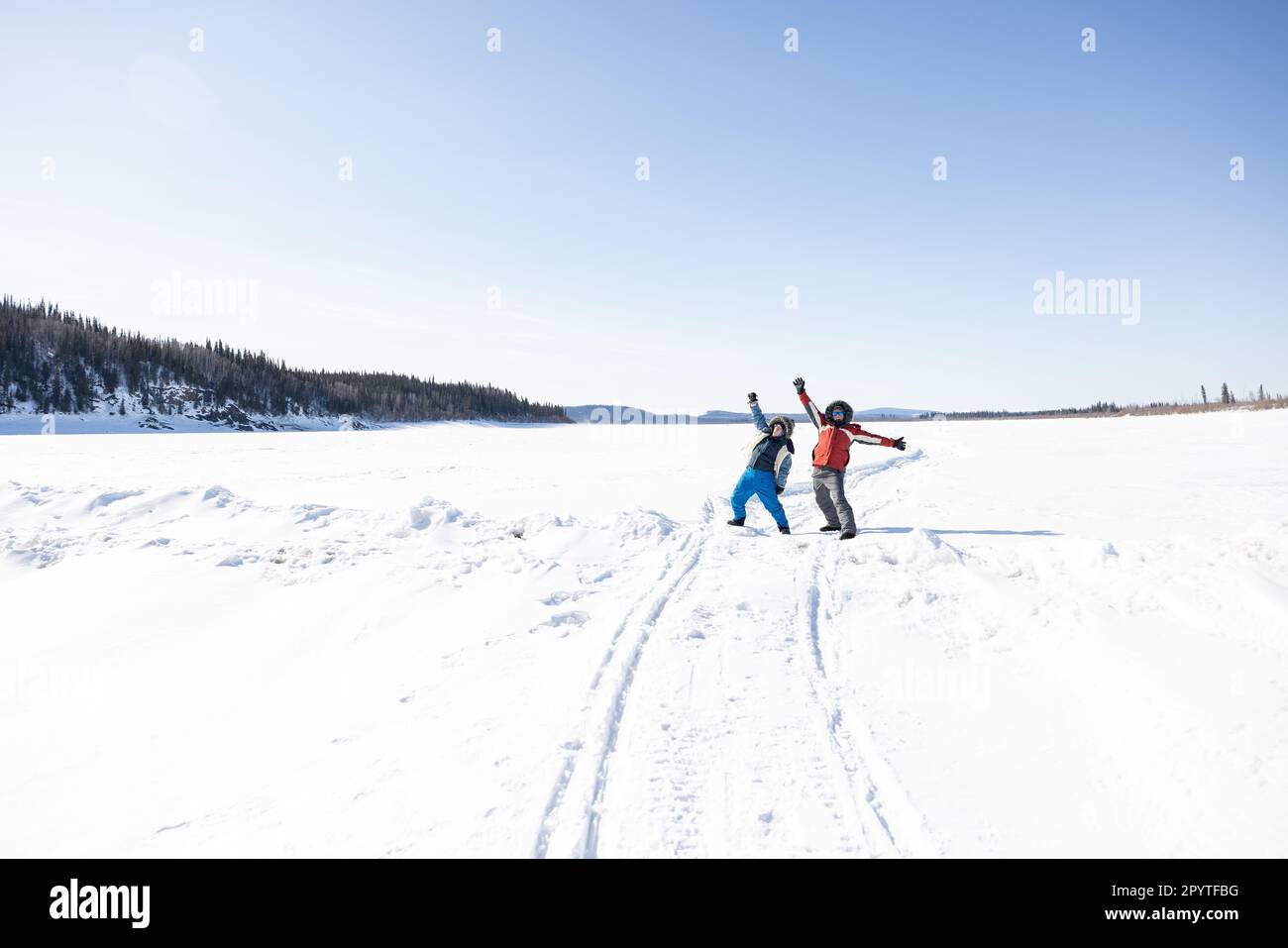Two happy people on the frozen Yukon River in Alaska Stock Photo - Alamy