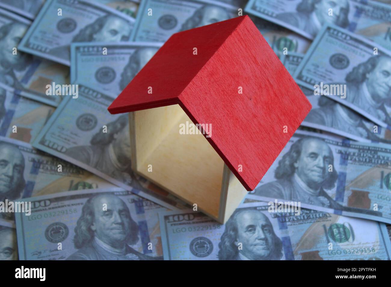 House on top of pile of money. Real estate and property industry ...