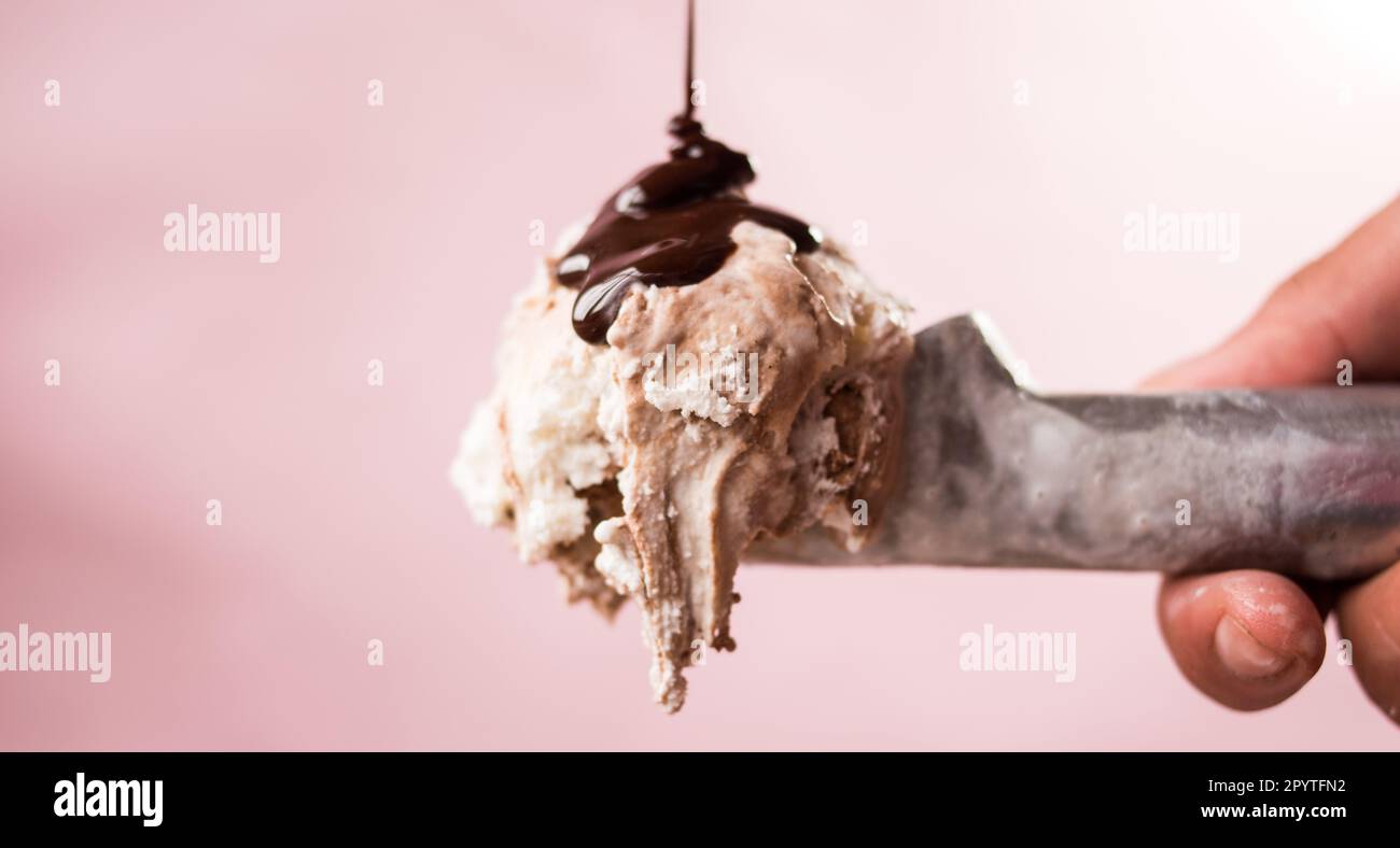 Hand holding an ice cream scoop with ice cream Stock Photo - Alamy