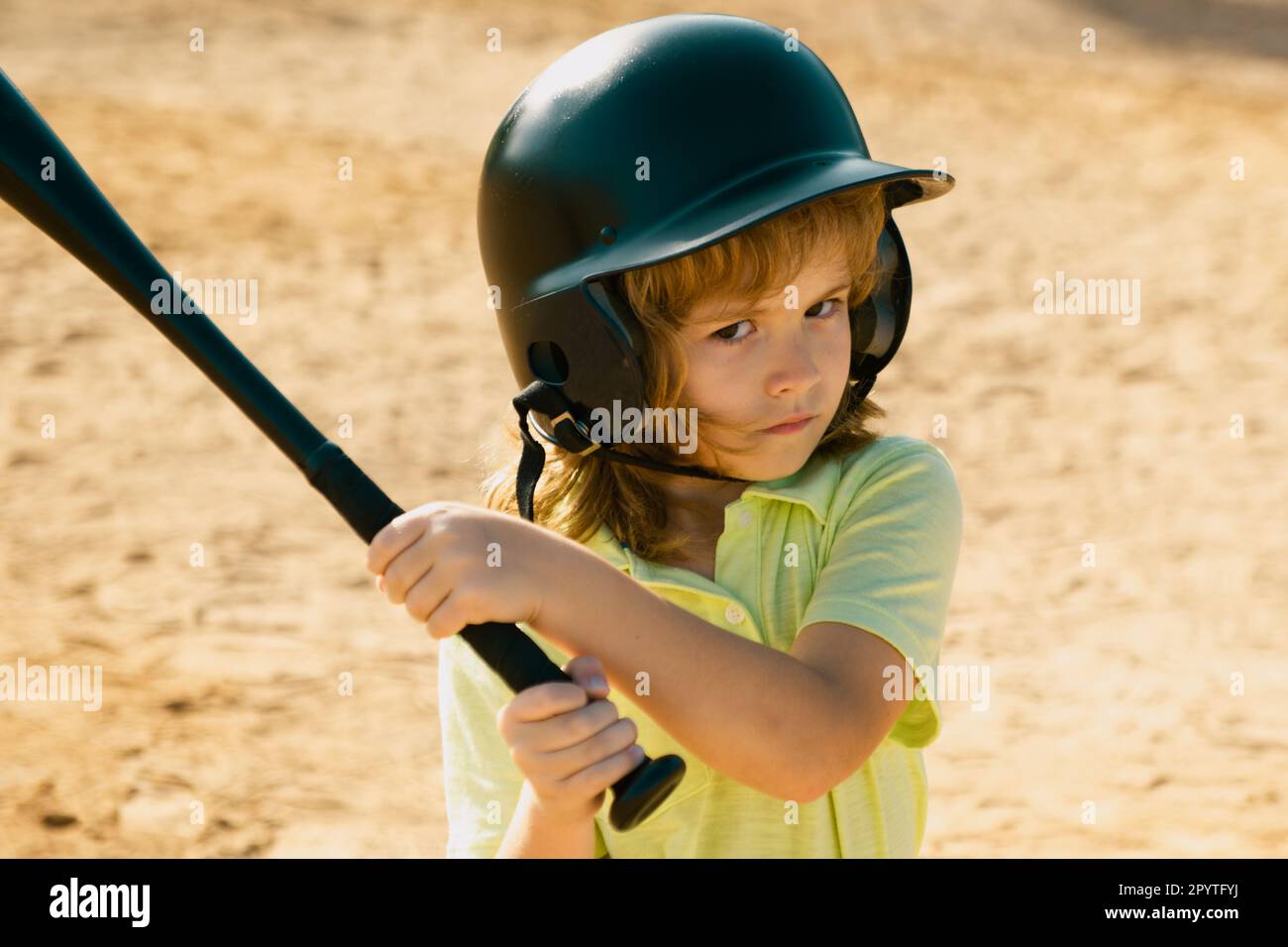 Boy in baseball helmet and baseball bat ready to bat Stock Photo - Alamy