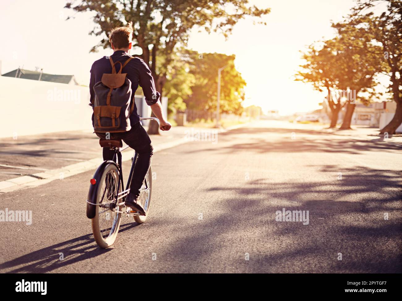 Bicycle, transport and back of man in road with lens flare for exercise ...