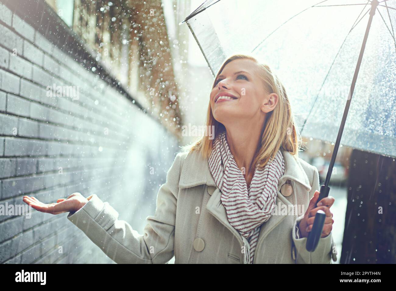 Smile, woman and raindrops in the city with umbrella, freedom and ...