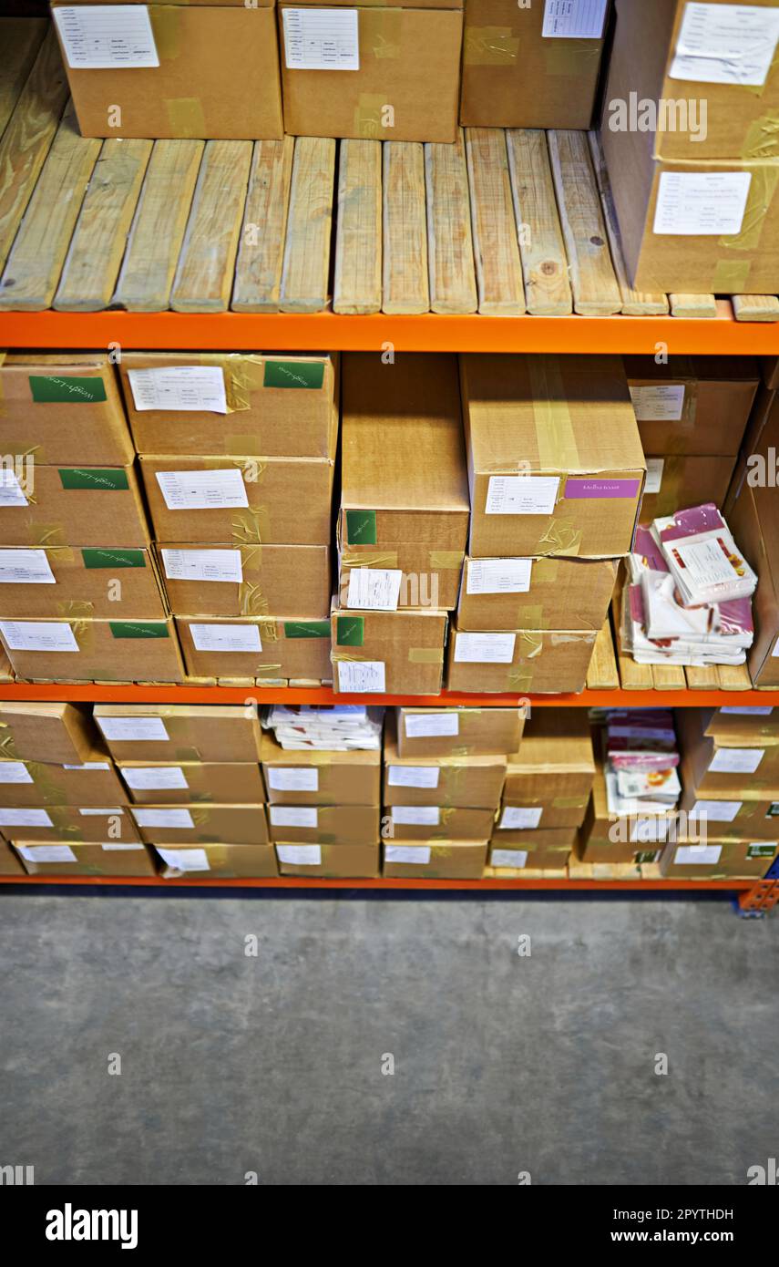 Stacked and ready to be delivered. Large warehouse storage shelves with ...