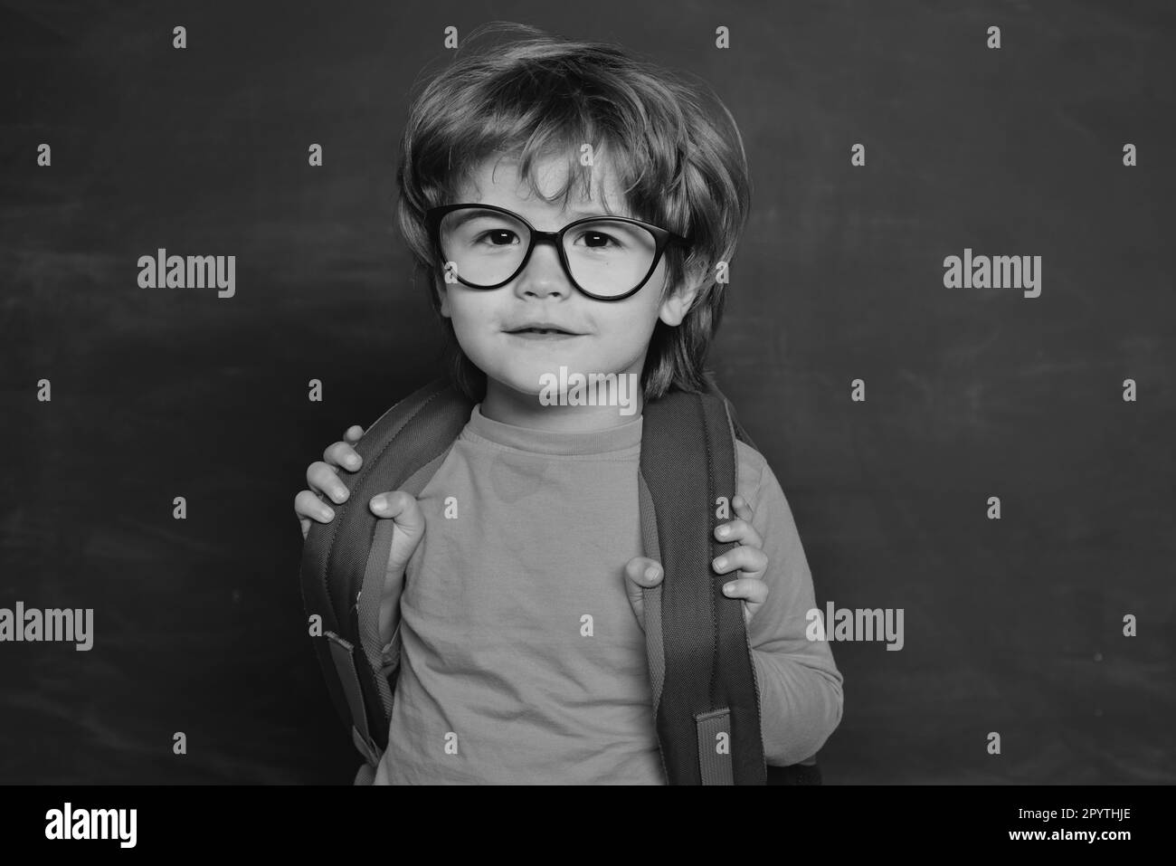 Cheerful smiling child at the blackboard. School kids against green ...