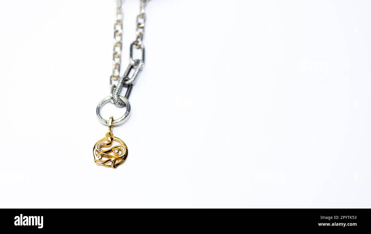 A shining gold chain necklace with a pendant attached to its end Stock ...